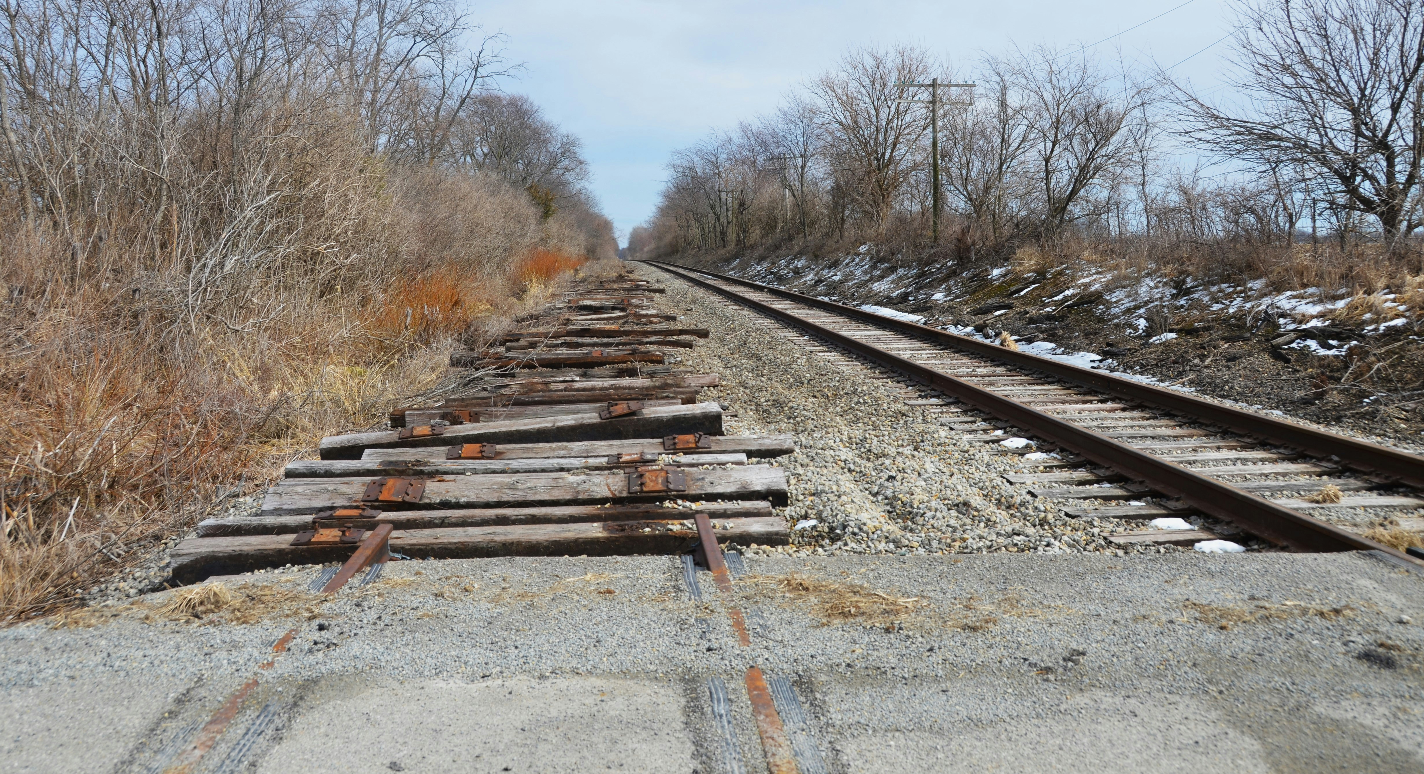 A train track with a bunch of train tracks next to it photo – Free ...