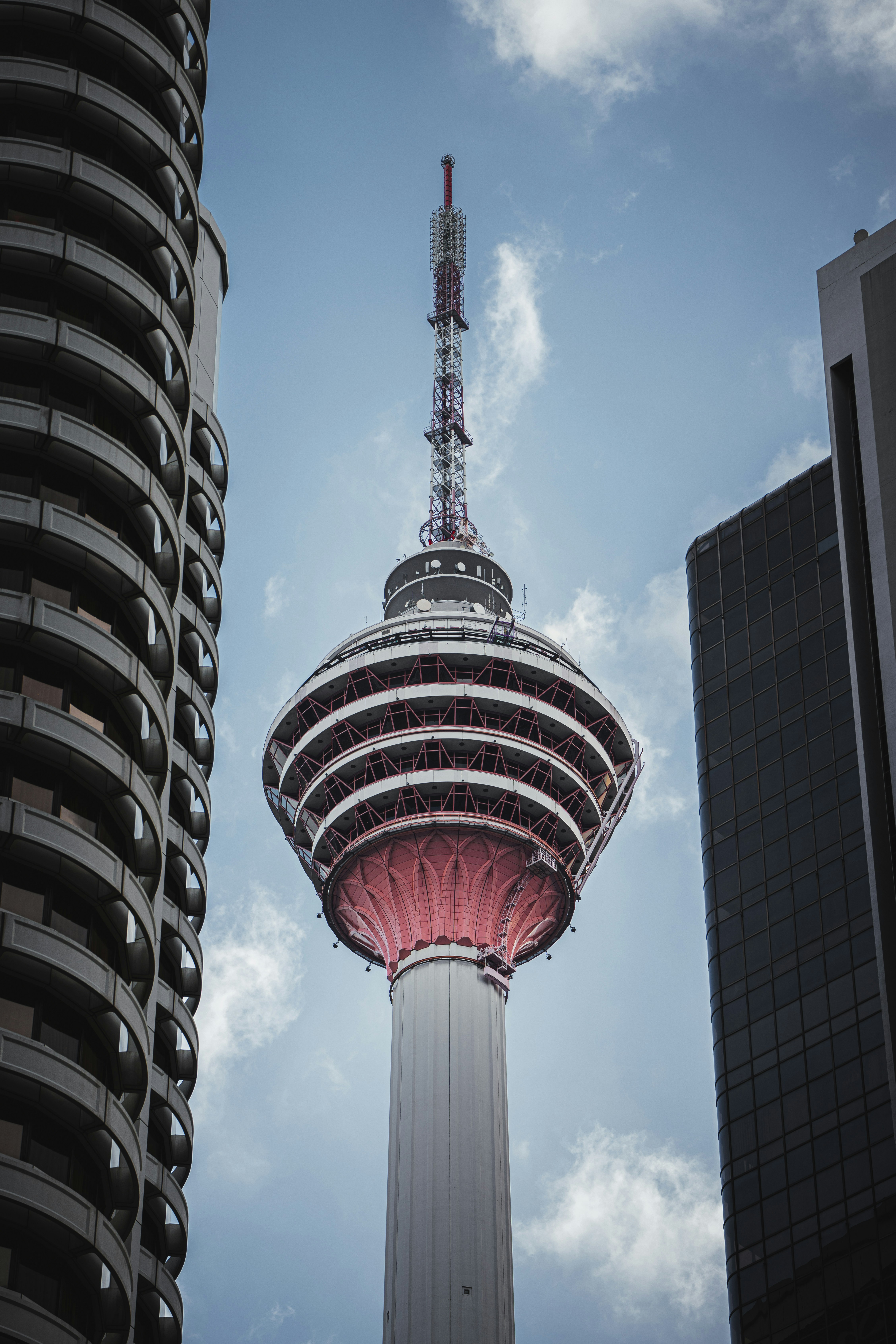 A tall tower with a sky scraper in the background photo – Free Building ...