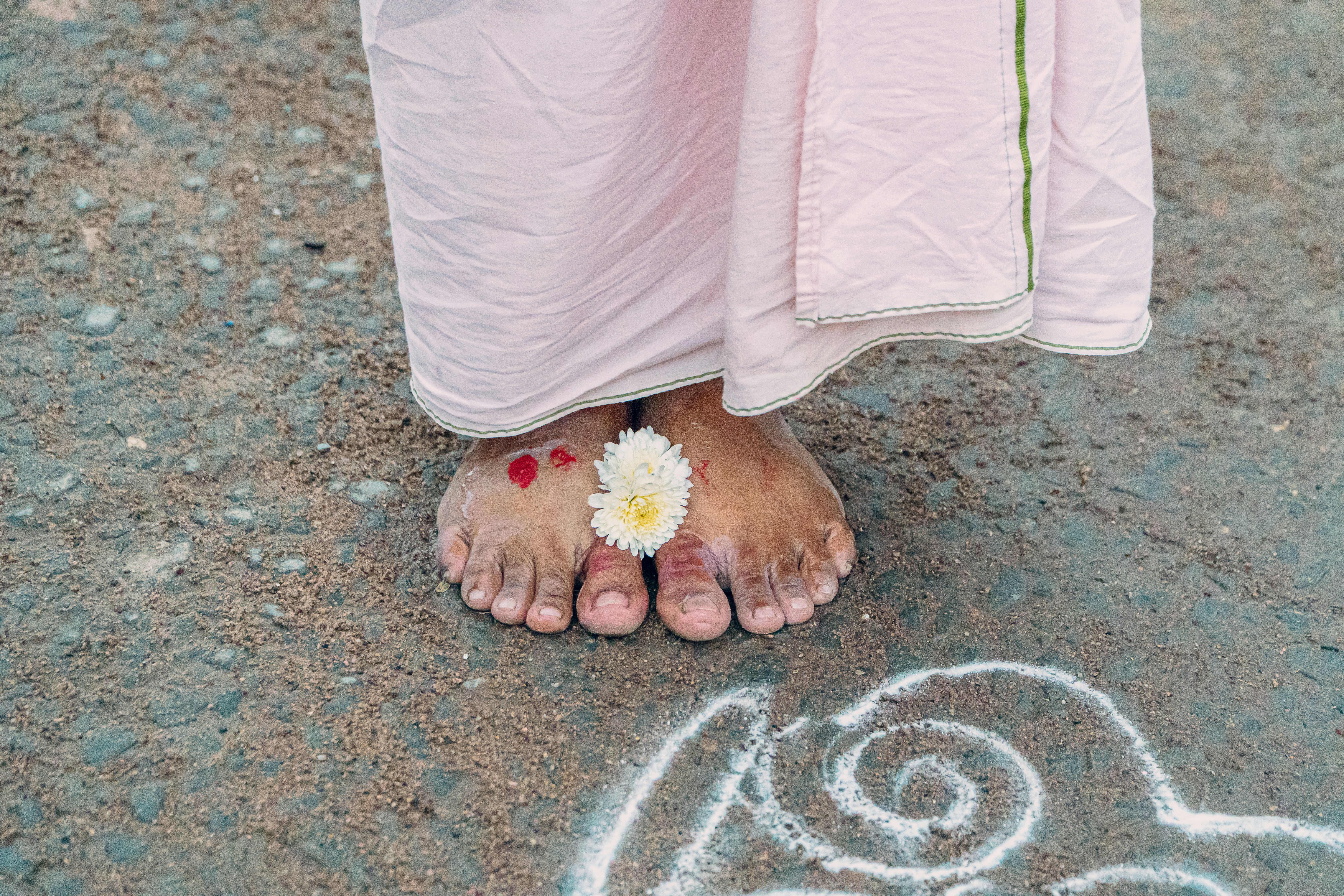 Bare Feet and a White Daisy: Traces of Light on a Dusty Ground