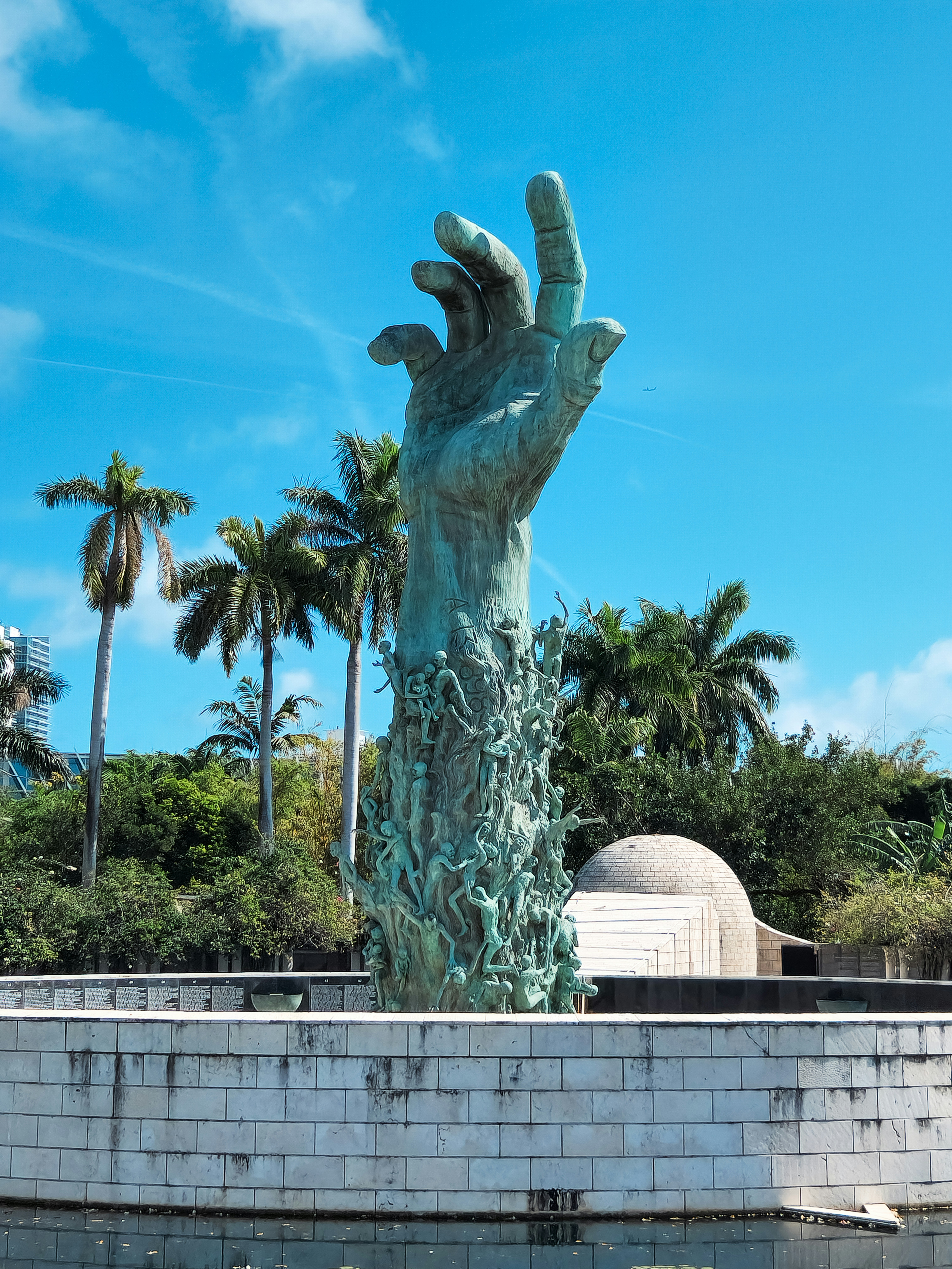 A statue of a hand reaching out of the water photo – Free Hand Image on ...
