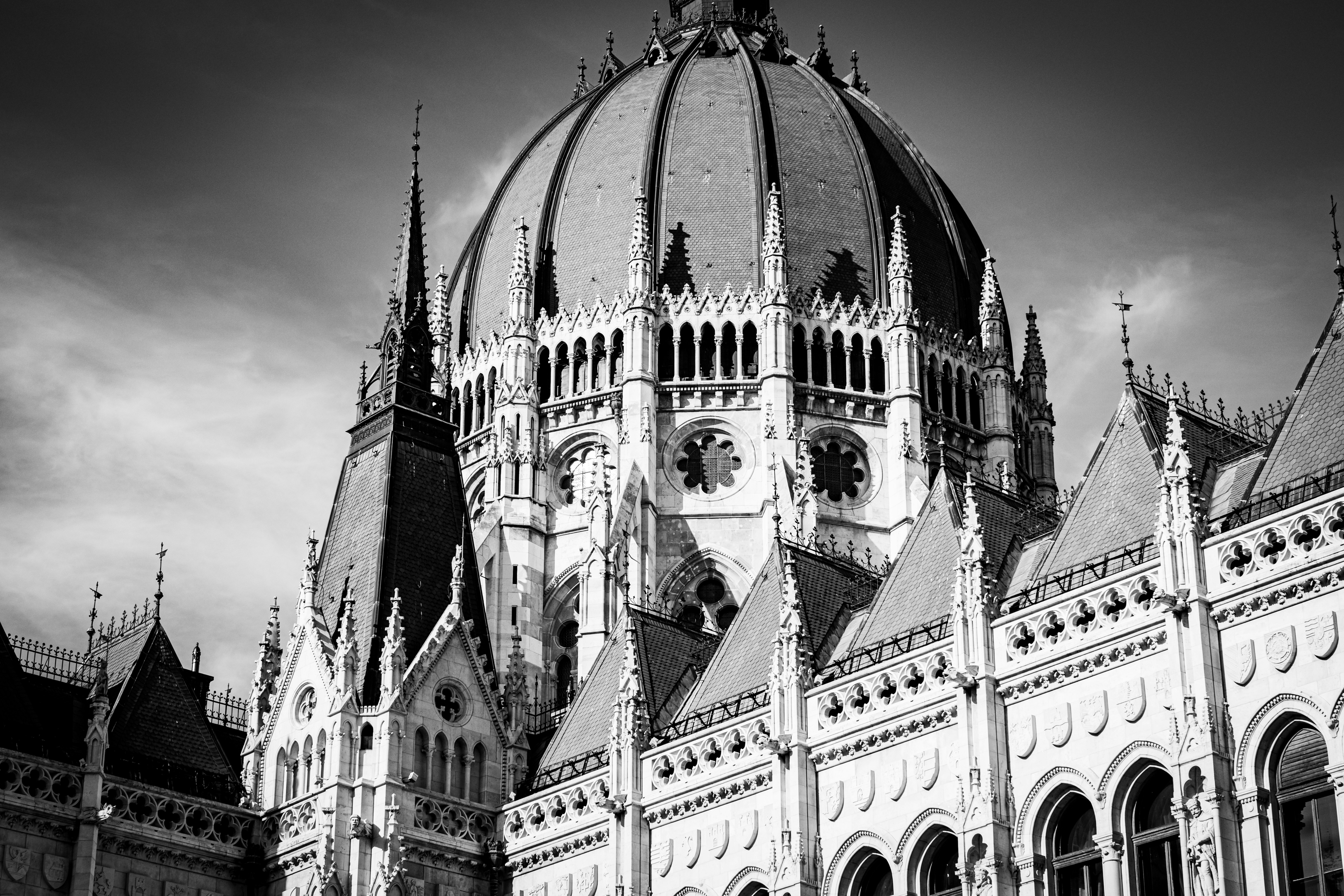 Detailed architectural spires and dome of a historic building in black and white.