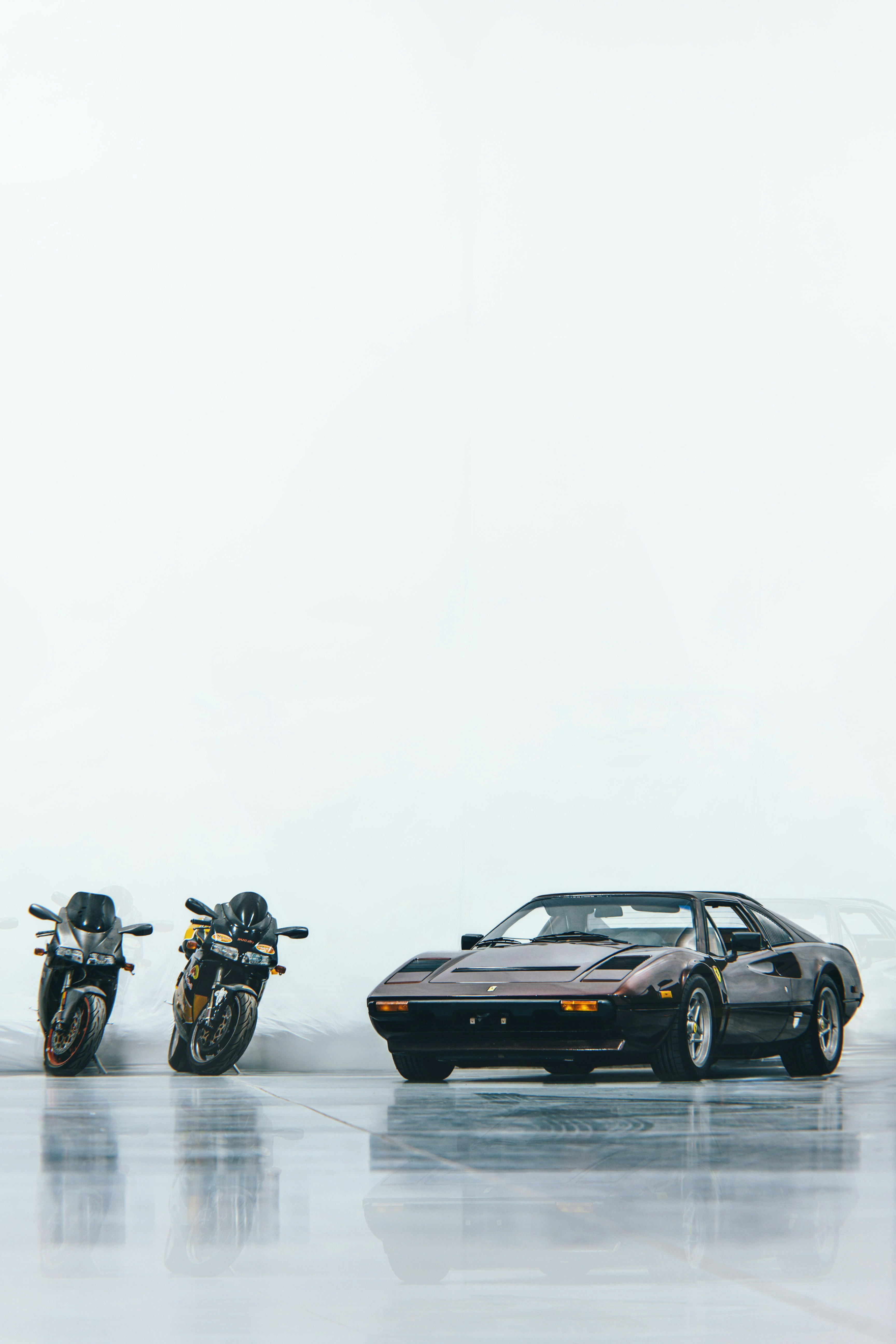 A group of motorcycles parked next to a car photo – Free Car Image on ...
