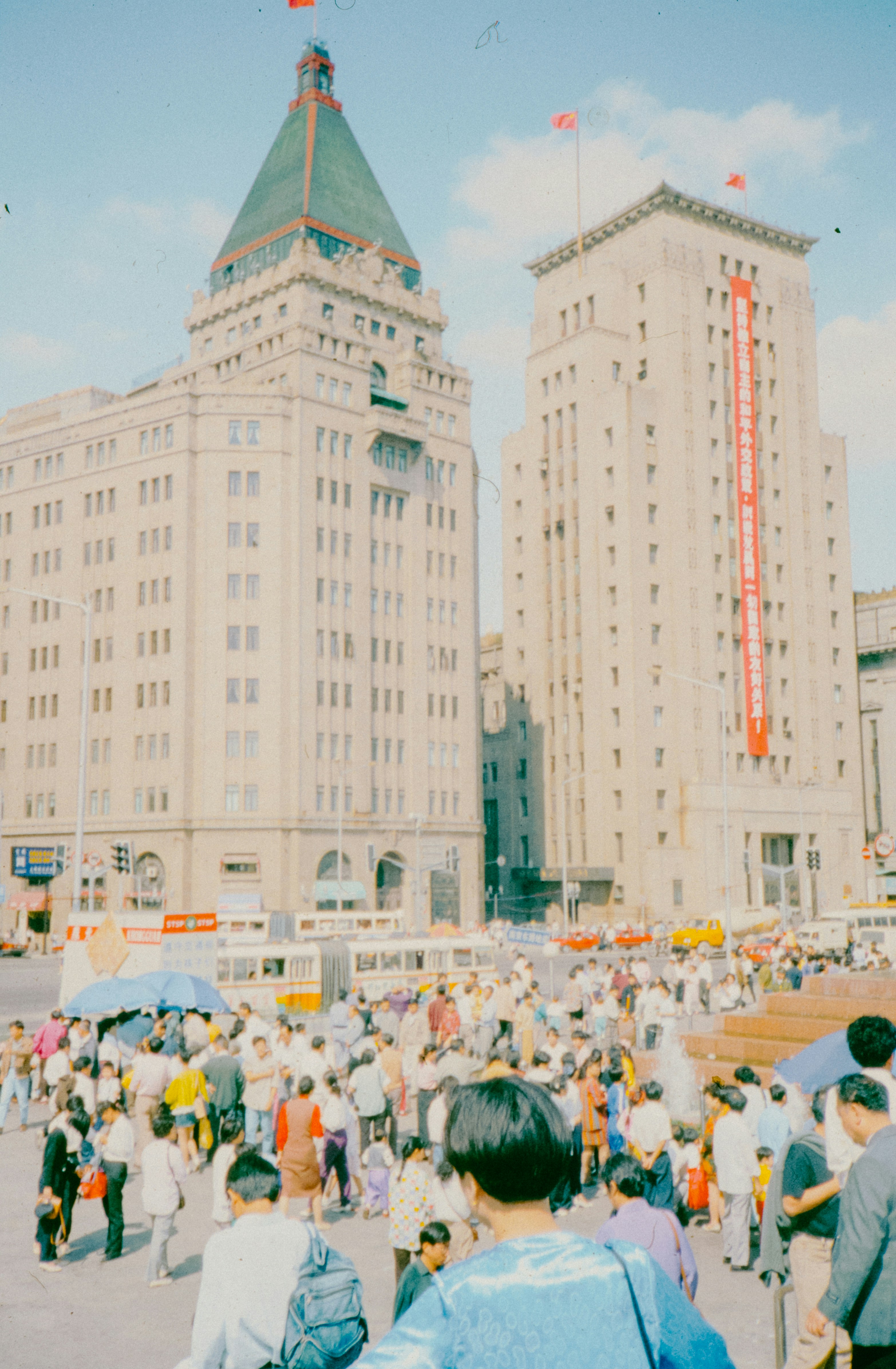 A crowd of people standing in front of tall buildings photo – Free Shot ...