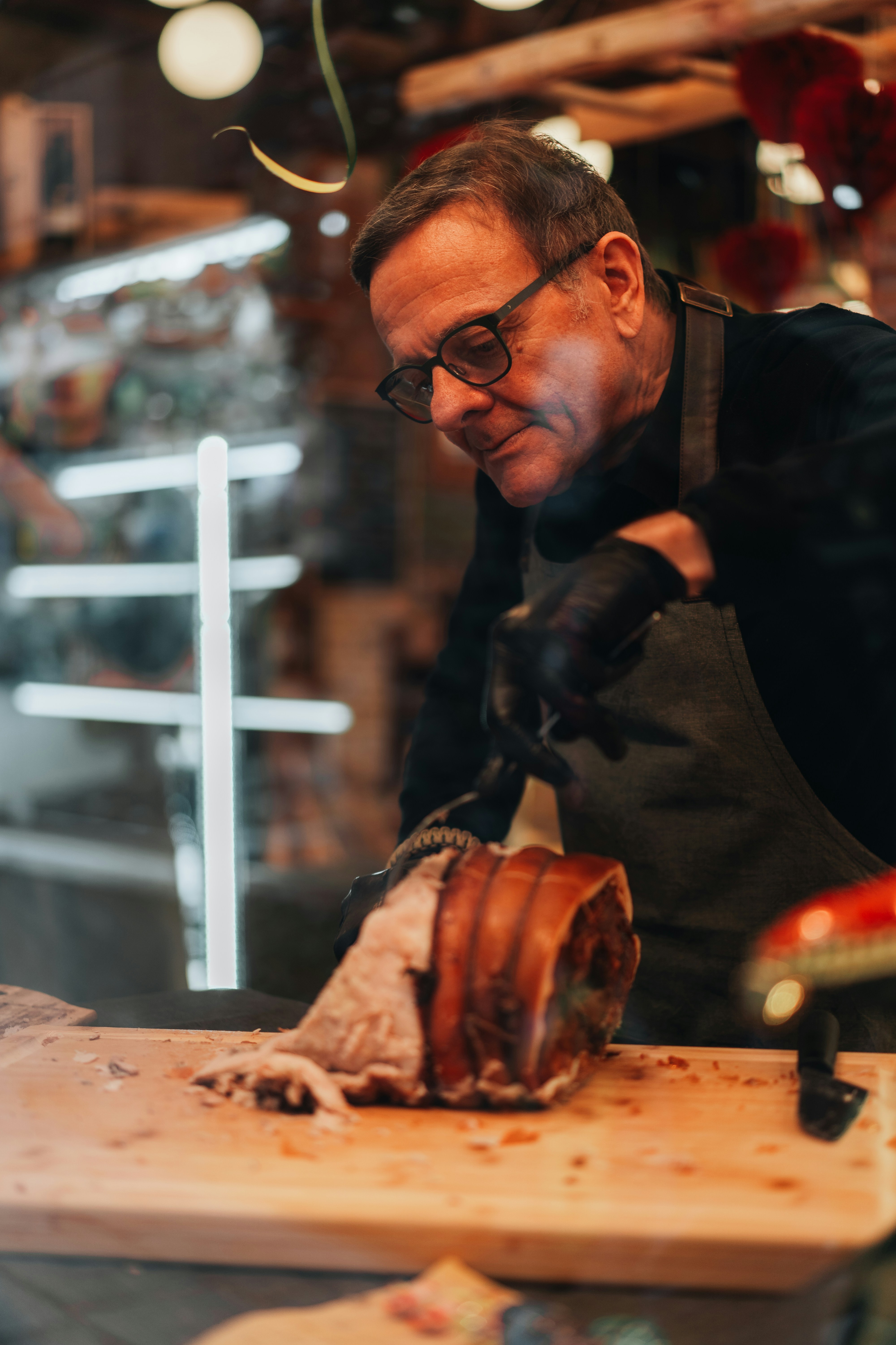 Butcher at Work: Andalusian Roast in a Neon-lit Market