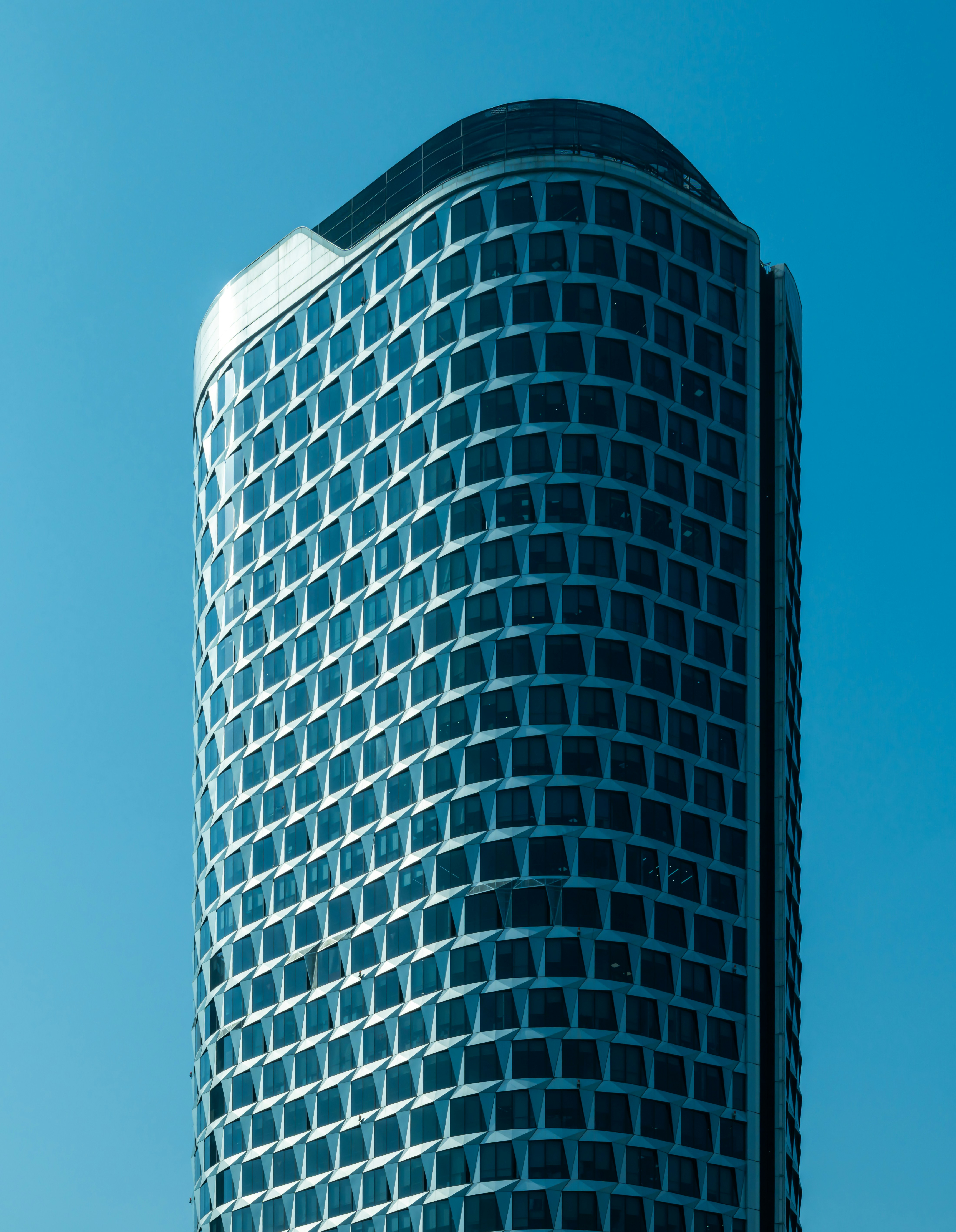 A very tall building with many windows on top of it photo – Free Office ...
