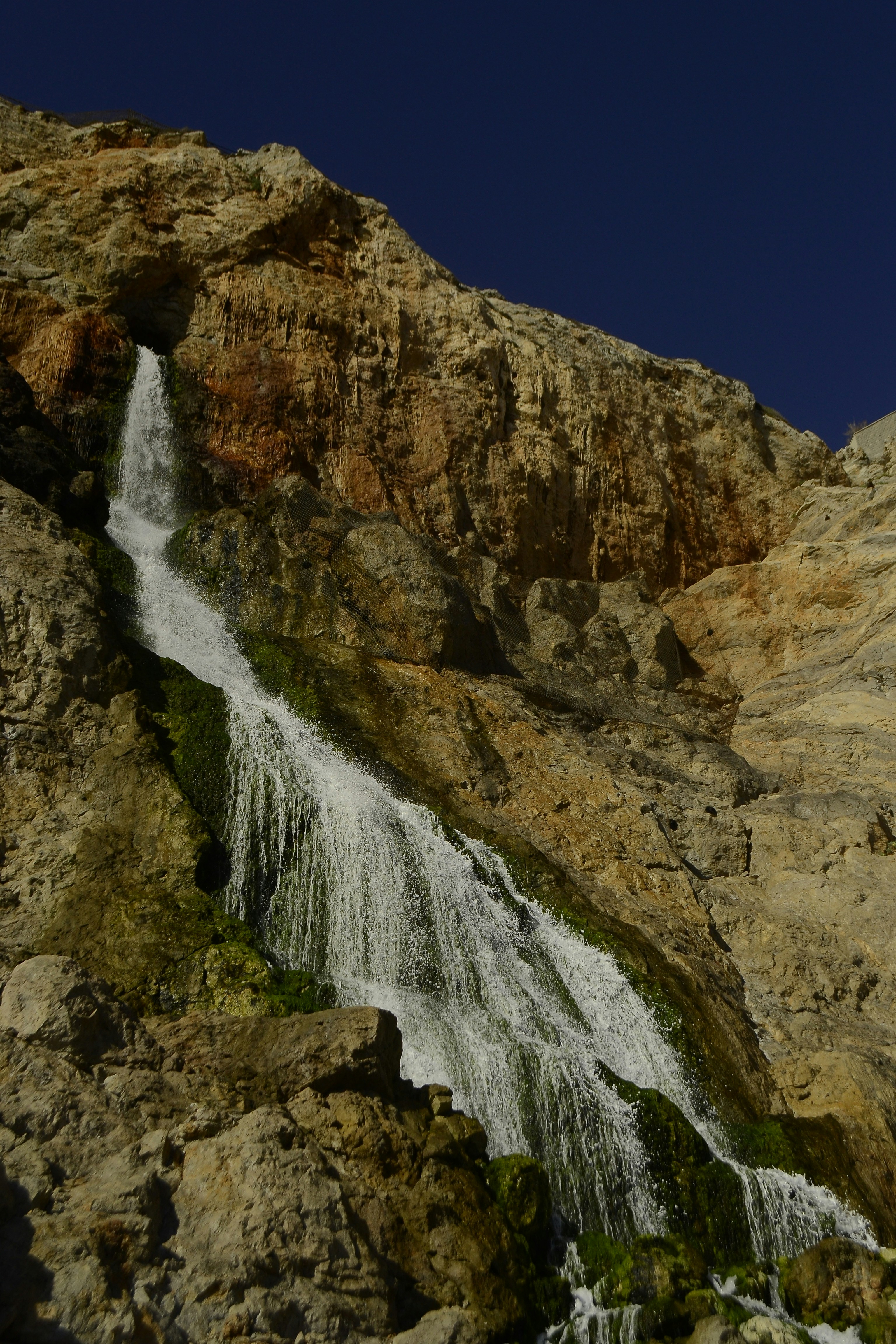 Streaking Cascade Between Weathered Cliffs