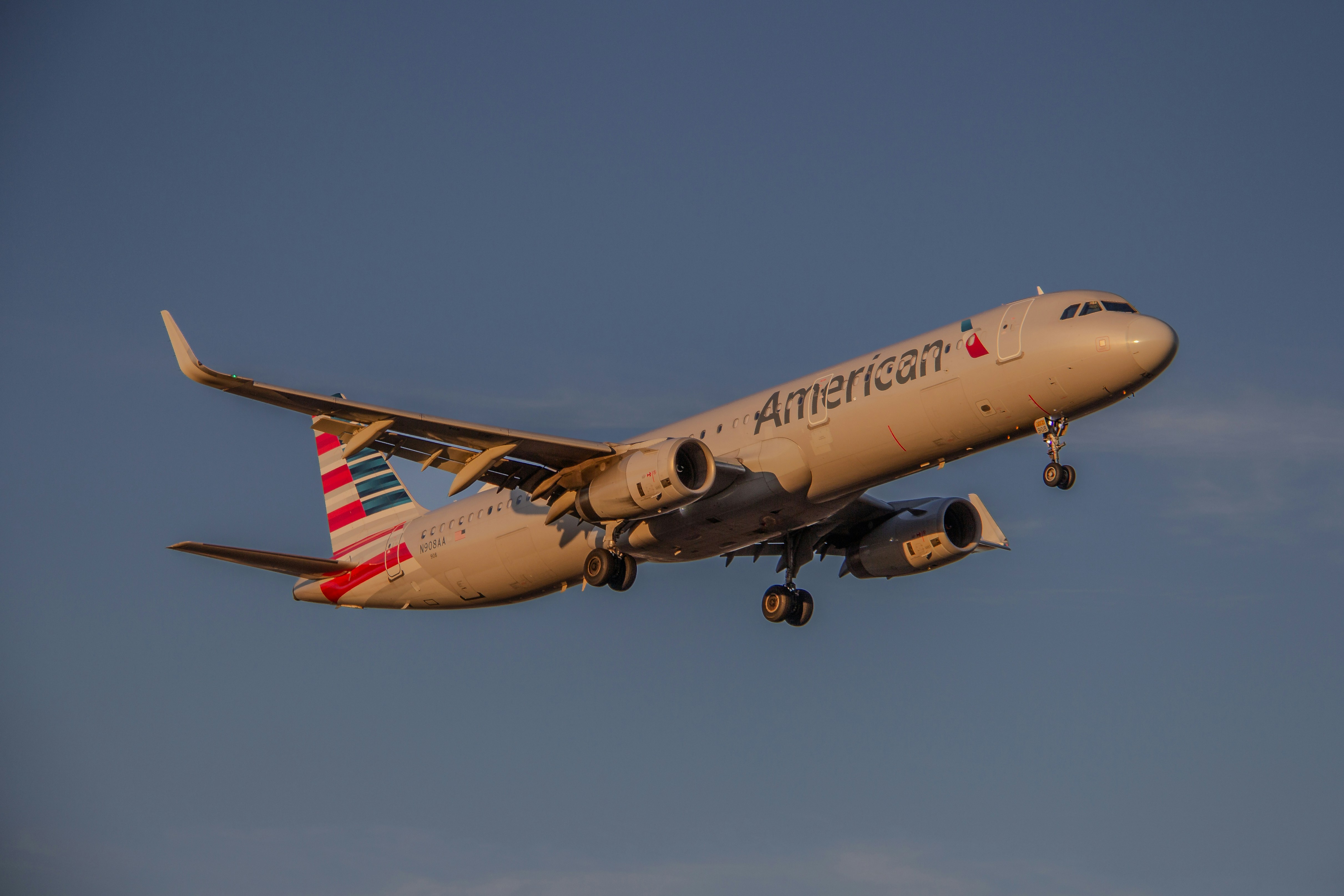 A large passenger jet flying through a blue sky photo – Free Airliner ...