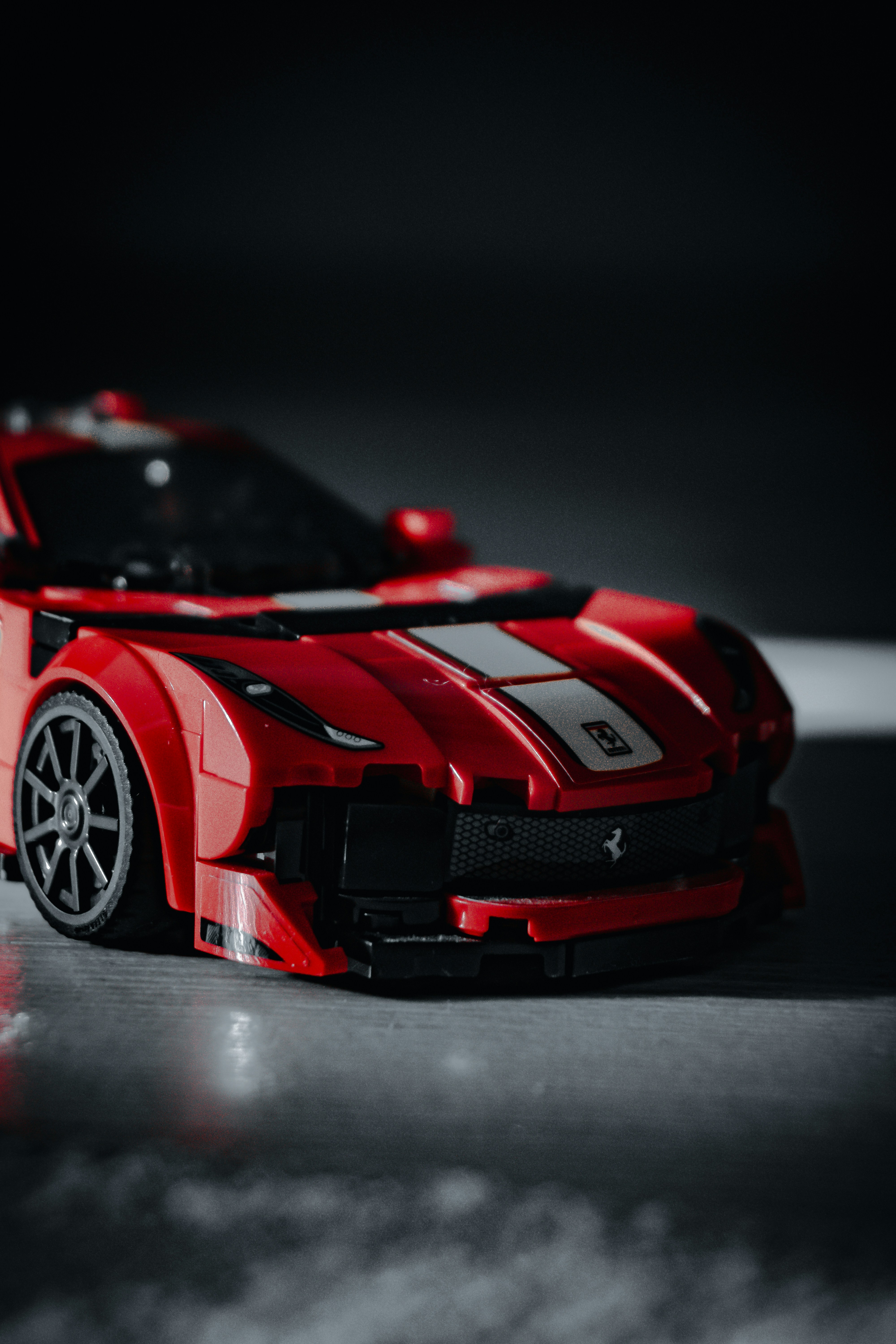 Crimson Contour: A Die-Cast Ferrari Emerges from the Shadows