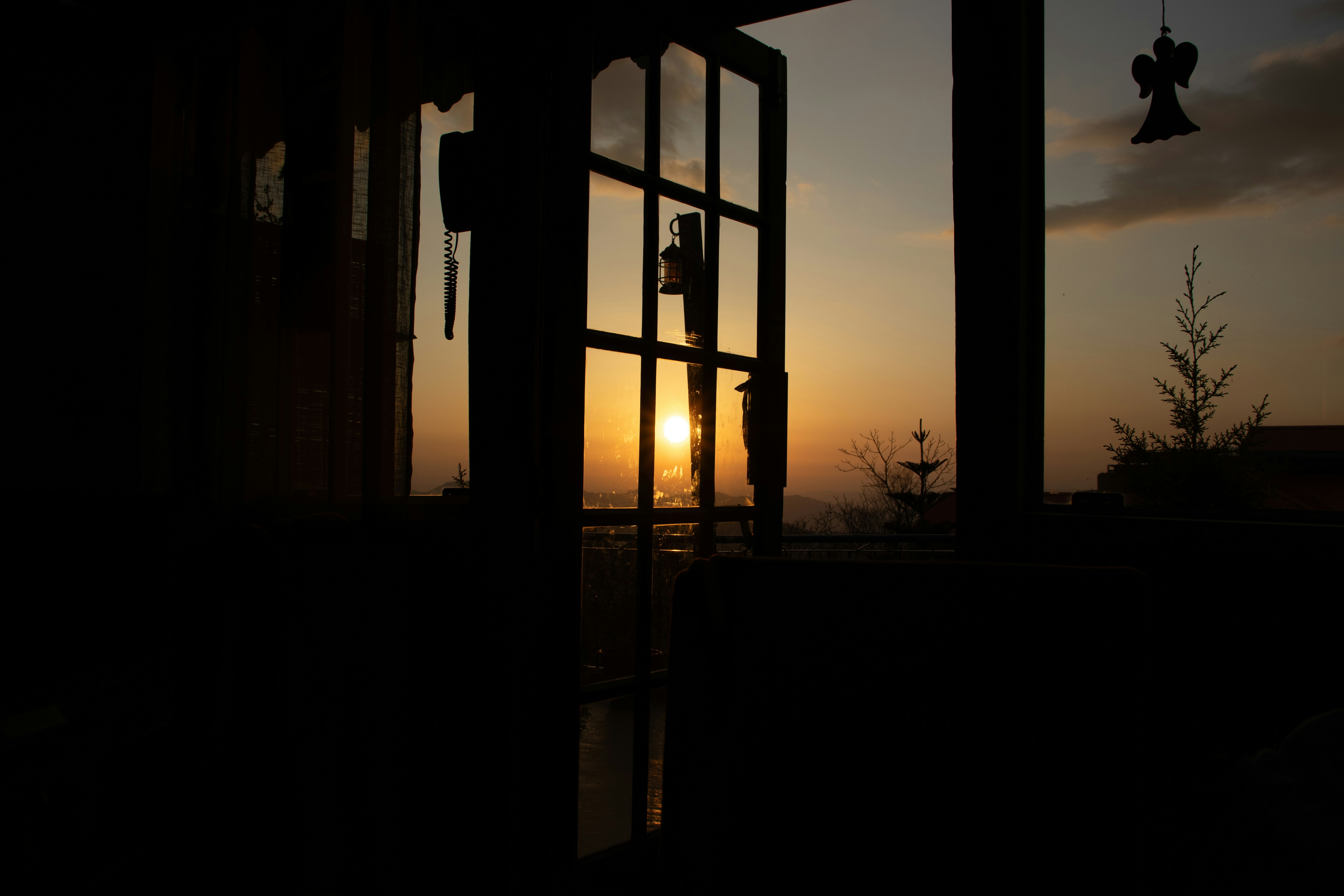 The sun is setting over the horizon of a building photo – Free Sunset ...