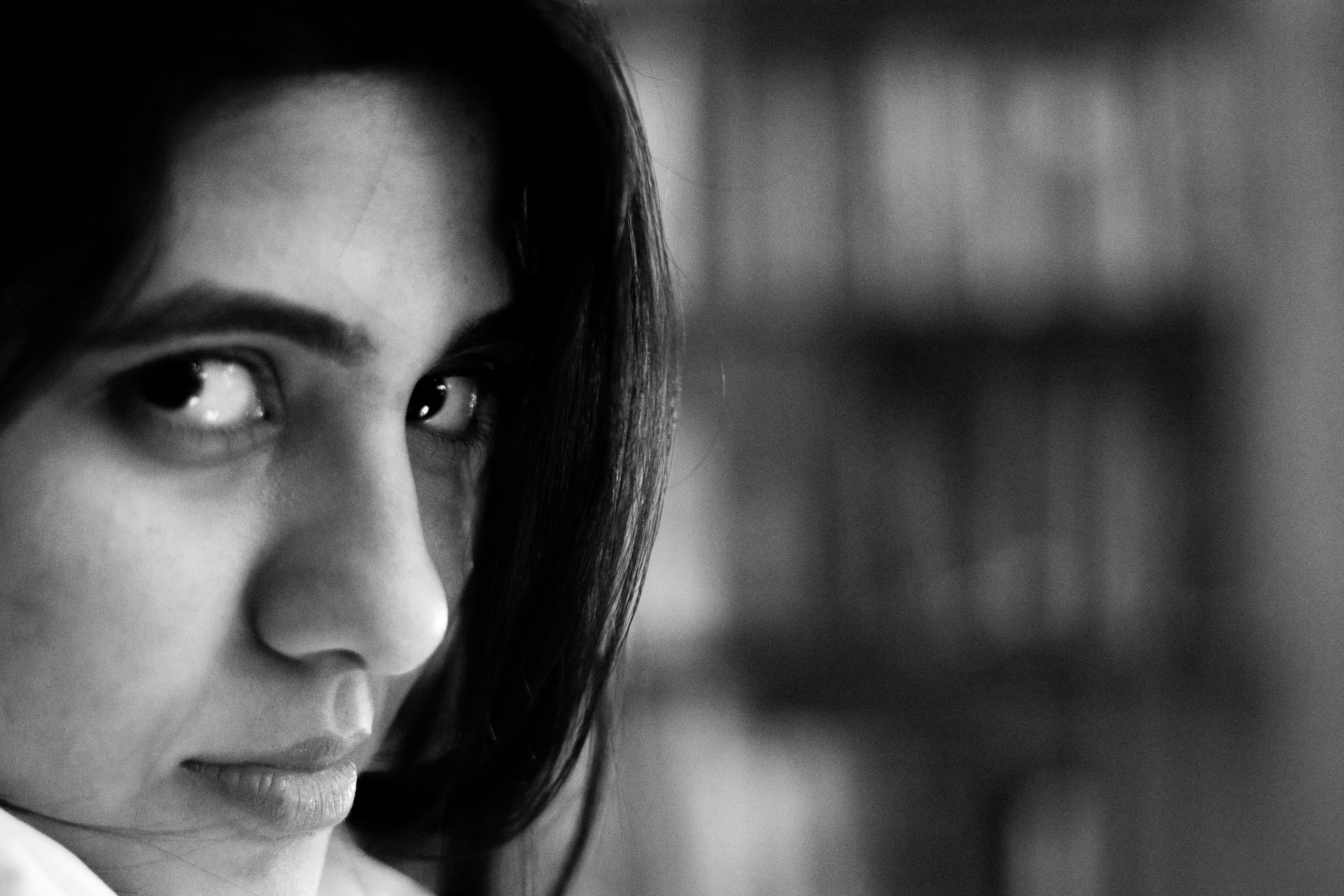 Monochrome Gaze: Left-Profile Intimacy Amid Soft Library Blur
