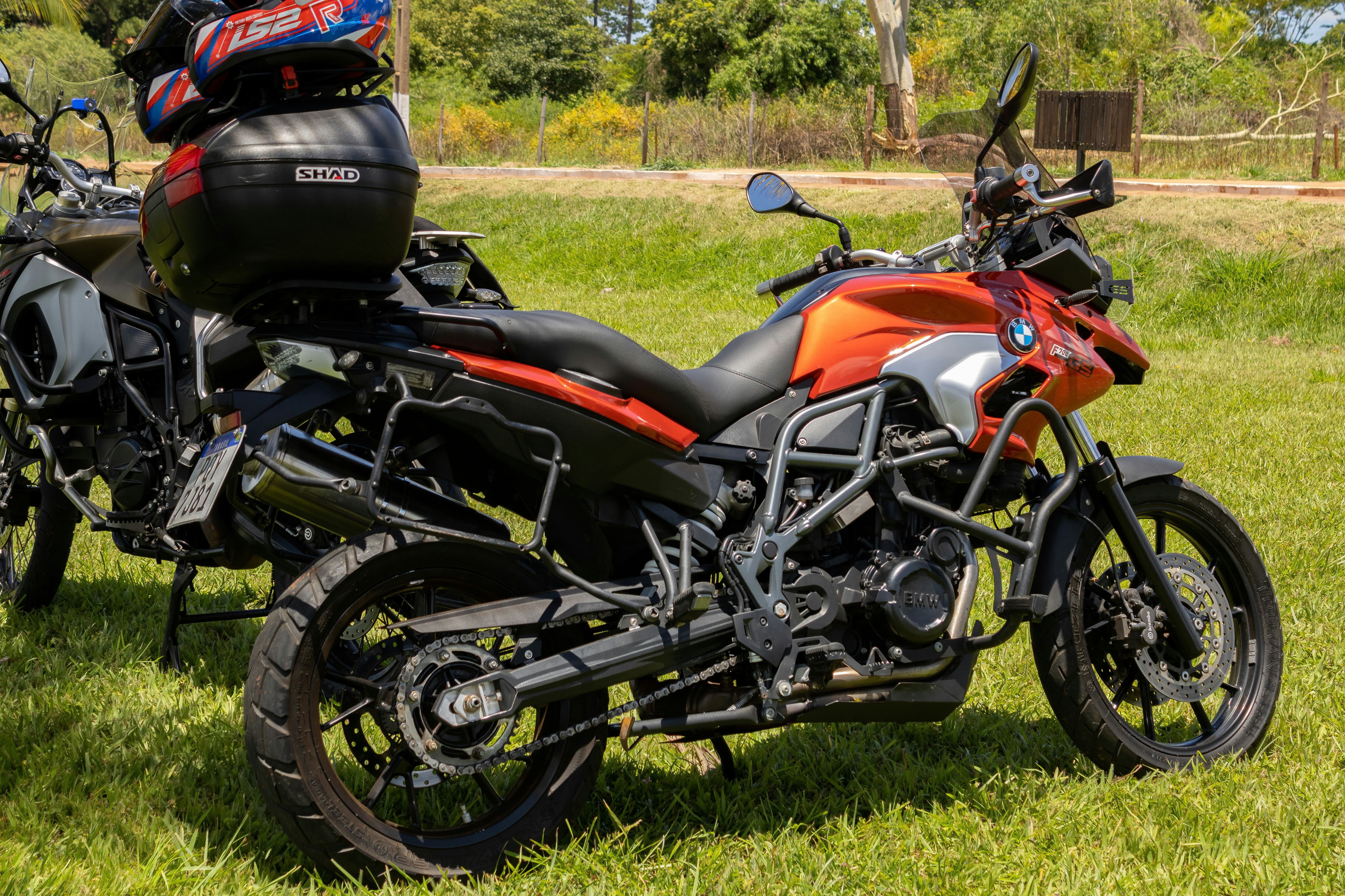 Dual Adventure Machines Resting in Sunlit Meadow