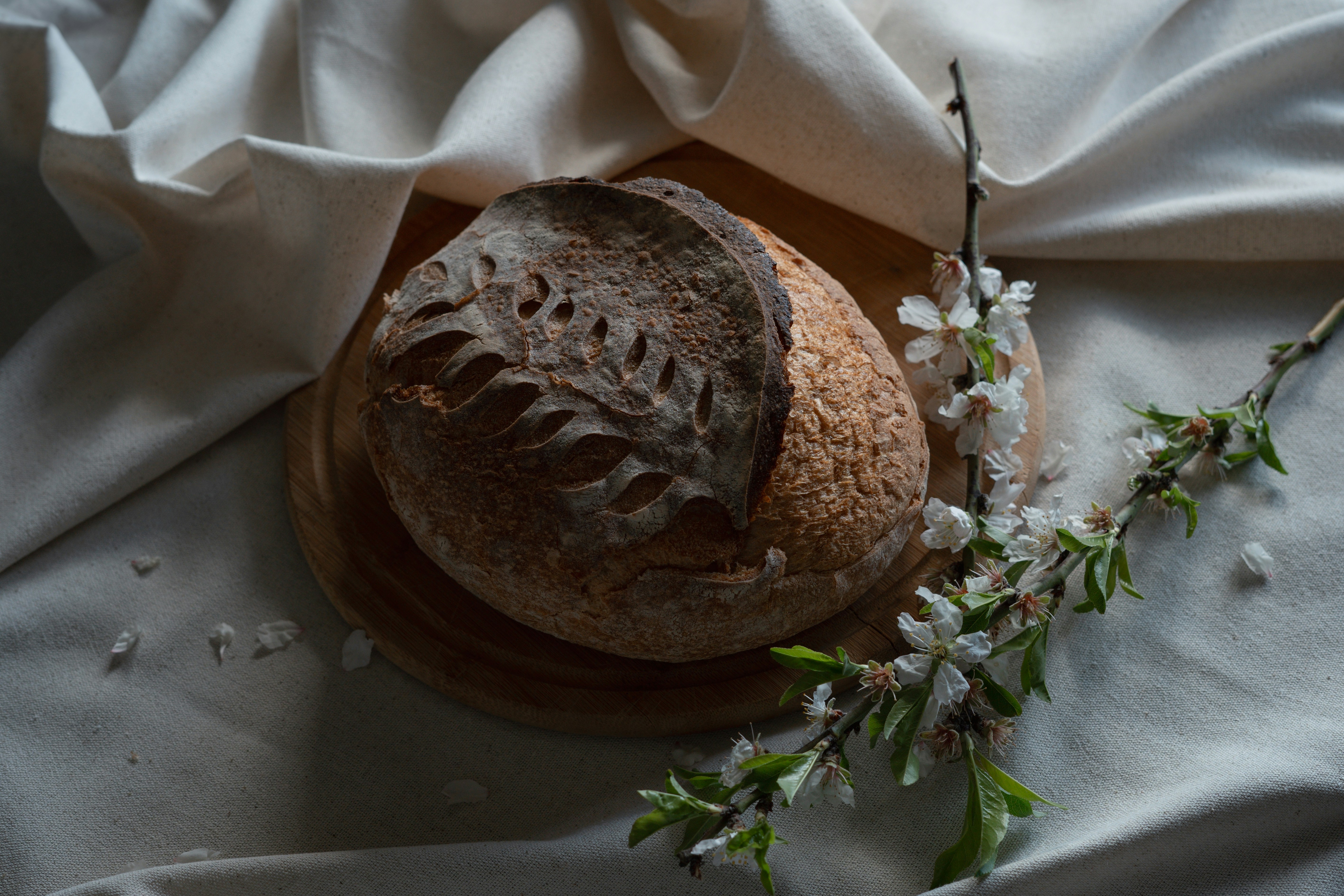 Crust and Linen: A Rustic Boule Framed by Thyme Blossoms