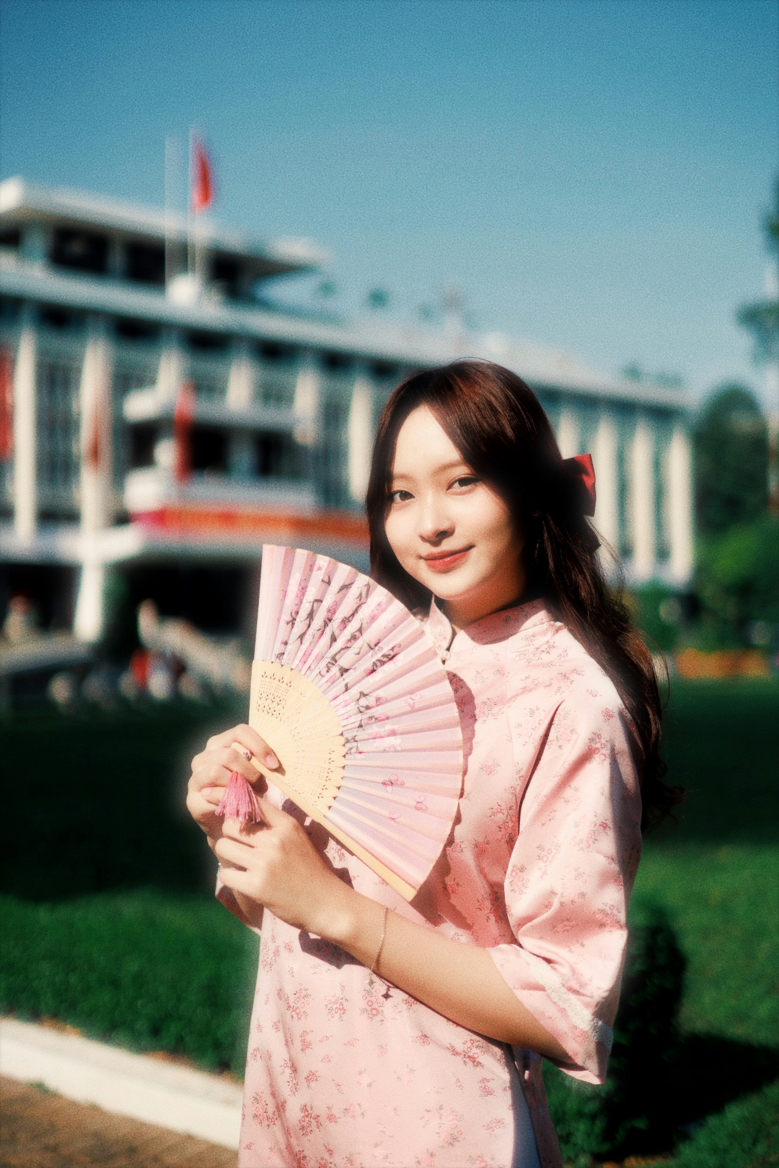A woman in a pink dress holding a pink fan photo – Free Face Image on ...