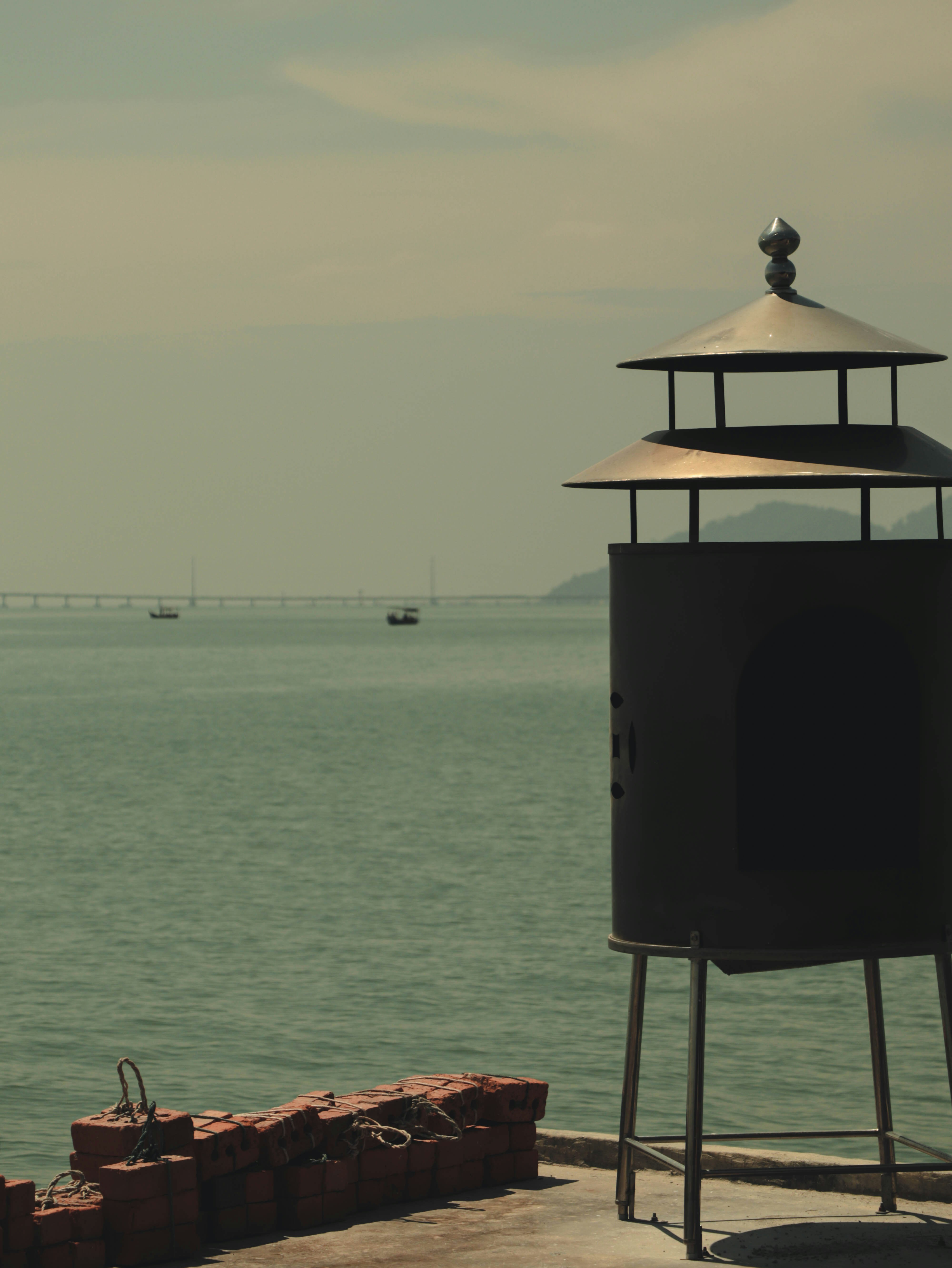 Lighthouse Shadow over Calm Waters