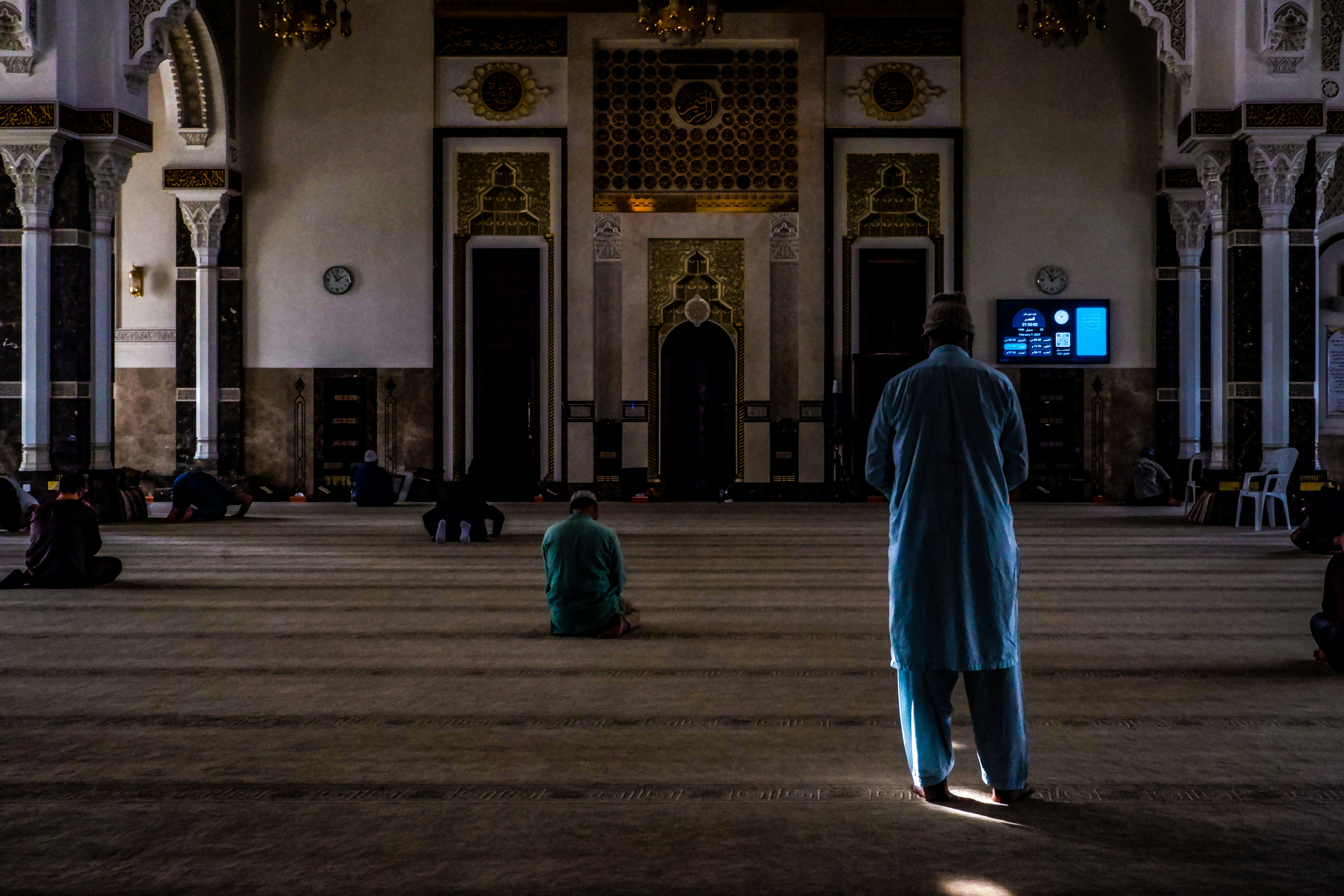 A person standing in a large room with a TV