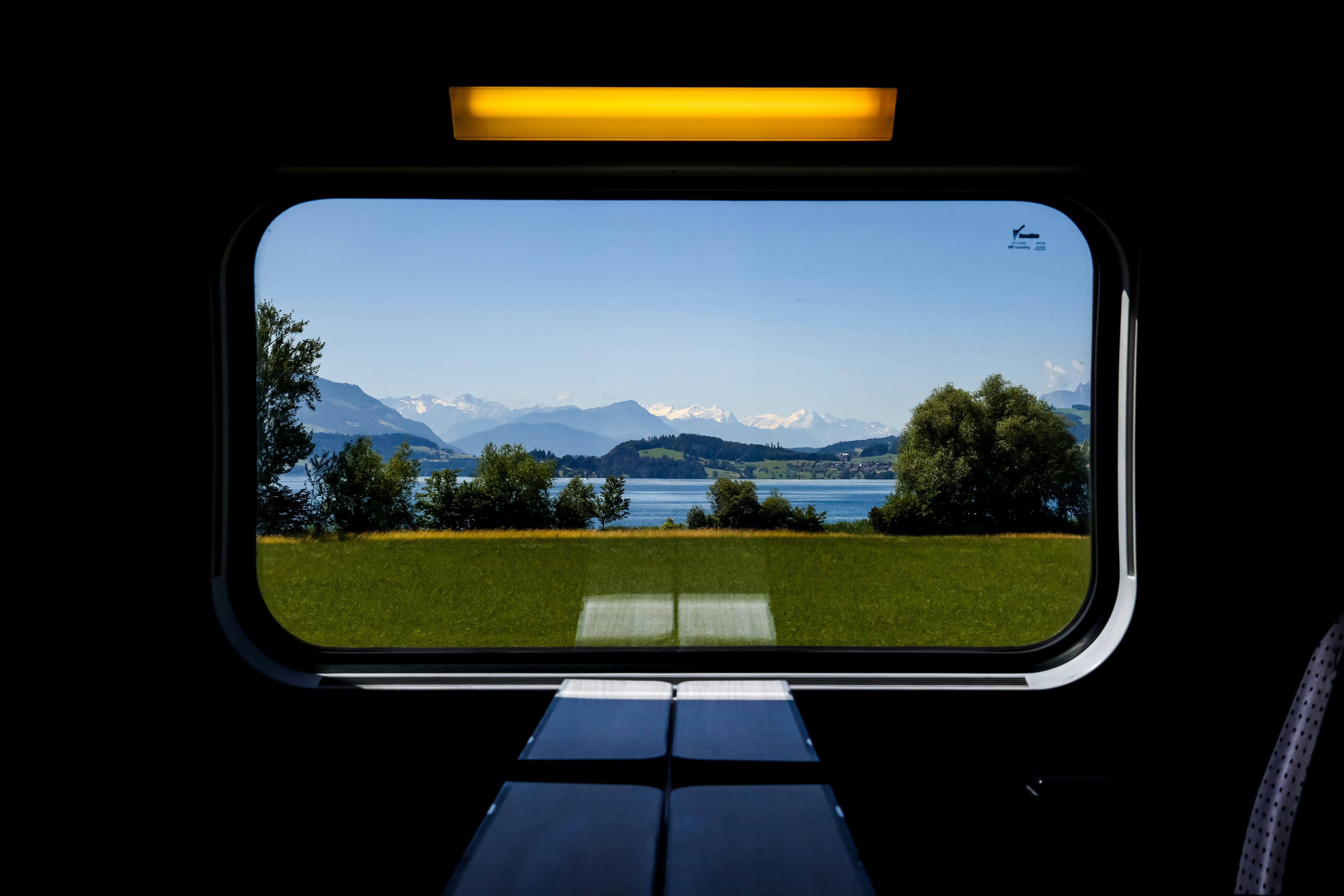 A view of a grassy field through a window photo – Free Switzerland ...