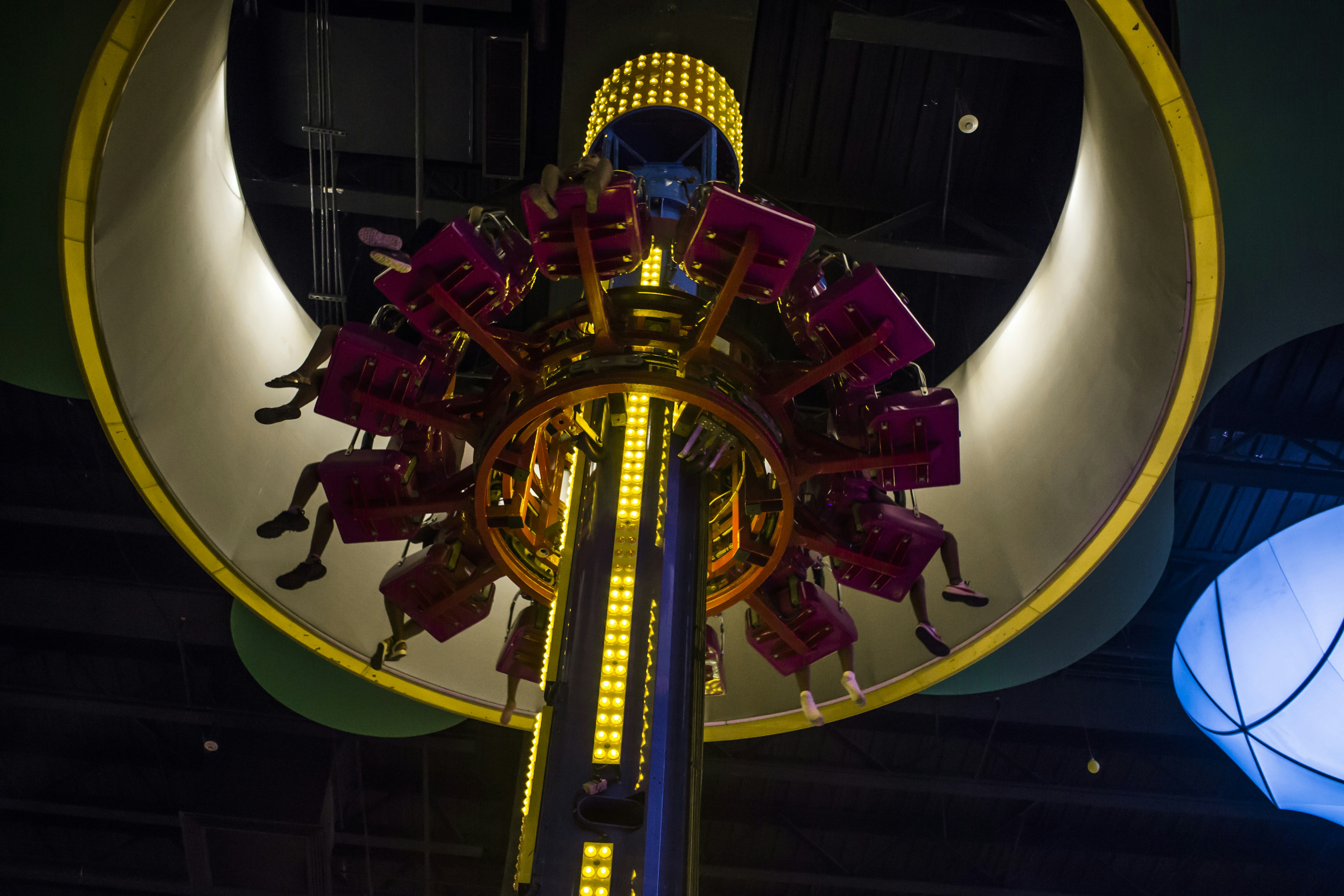 Rotating Thrill: A Neon-Centered Carousel of Adrenaline