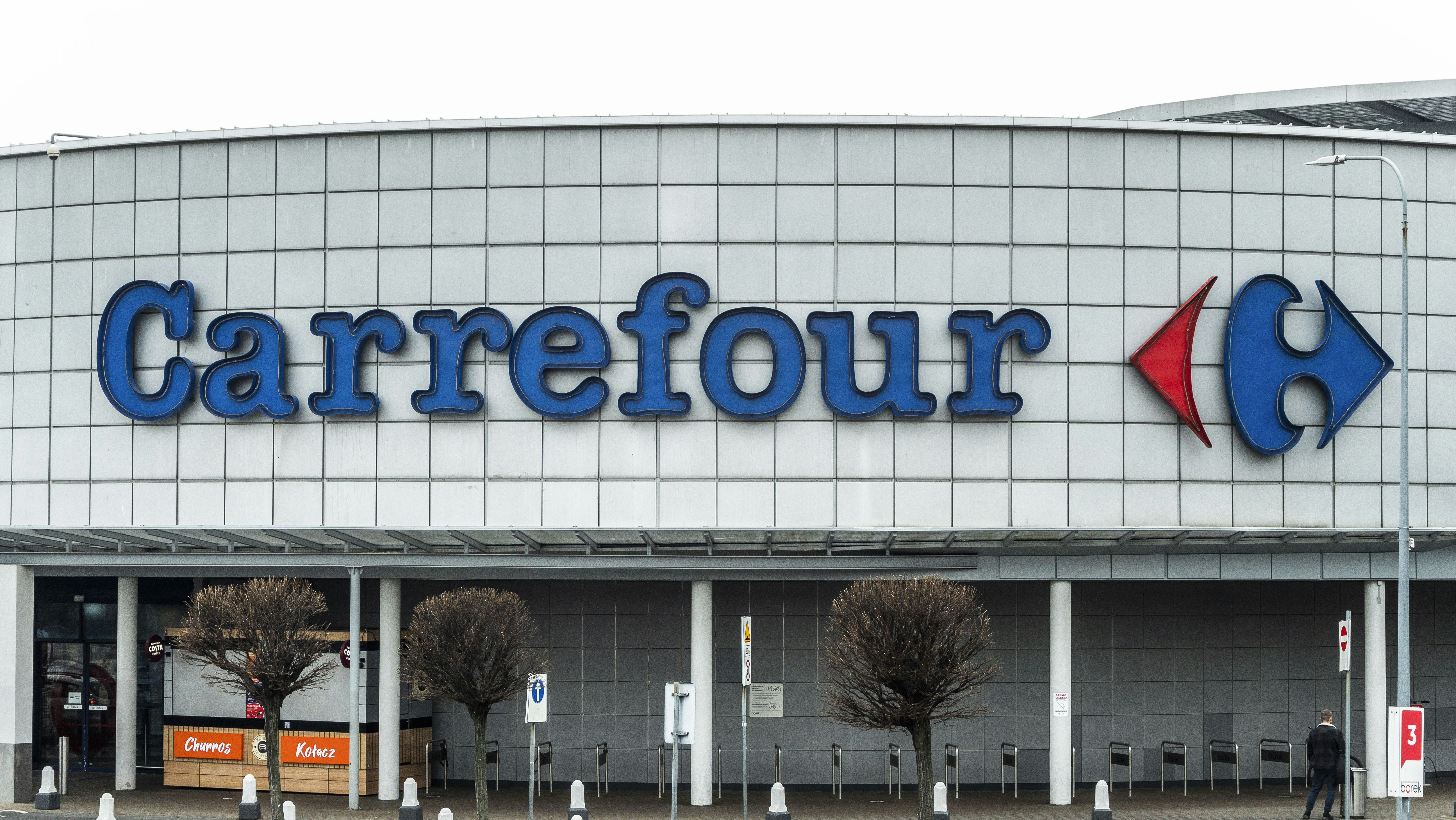 A large building with a sign that says carrefour photo – Free Car Image ...