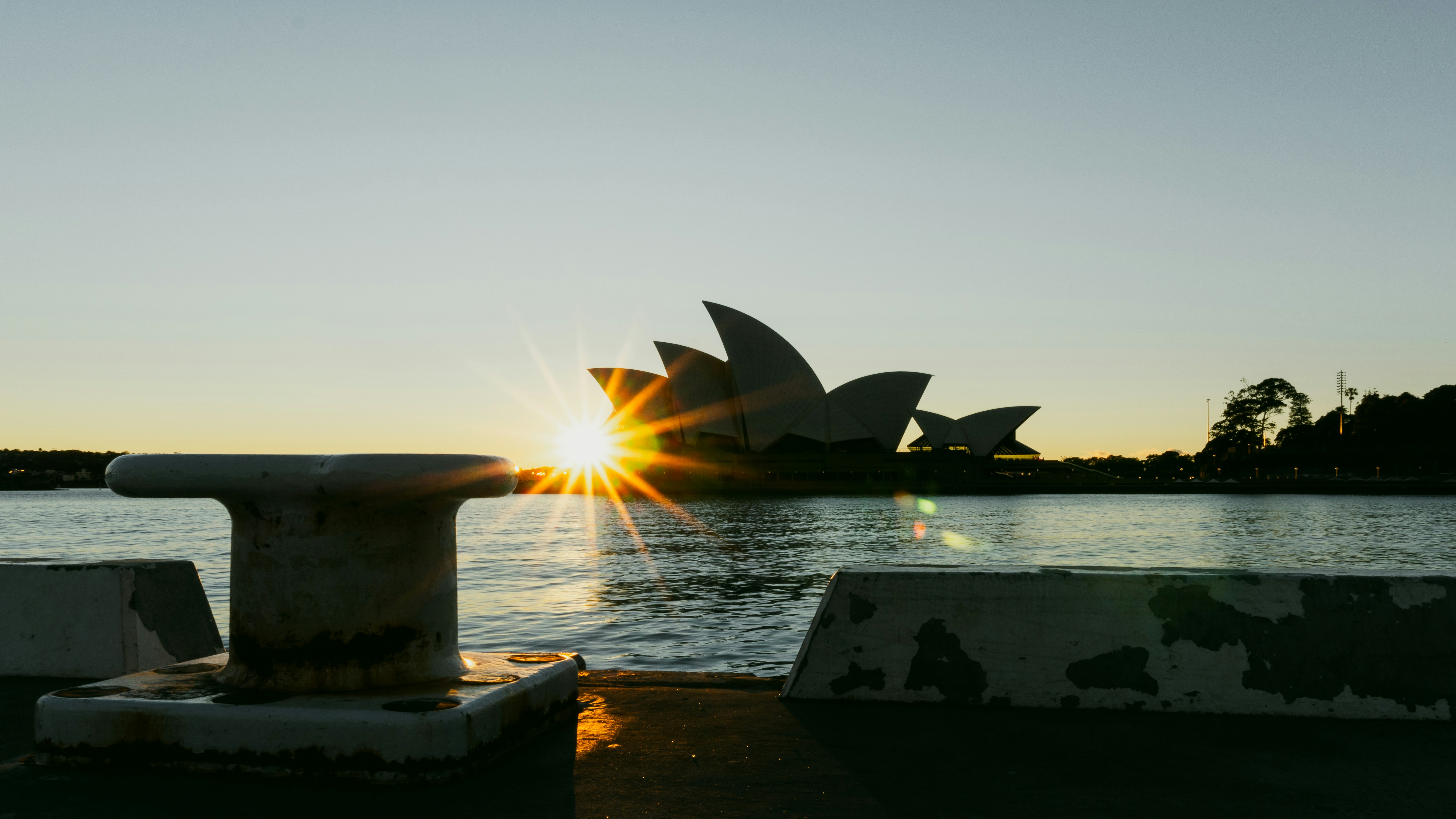 Sunstar Over Sydney Harbour: Opera House Silhouette at Dusk