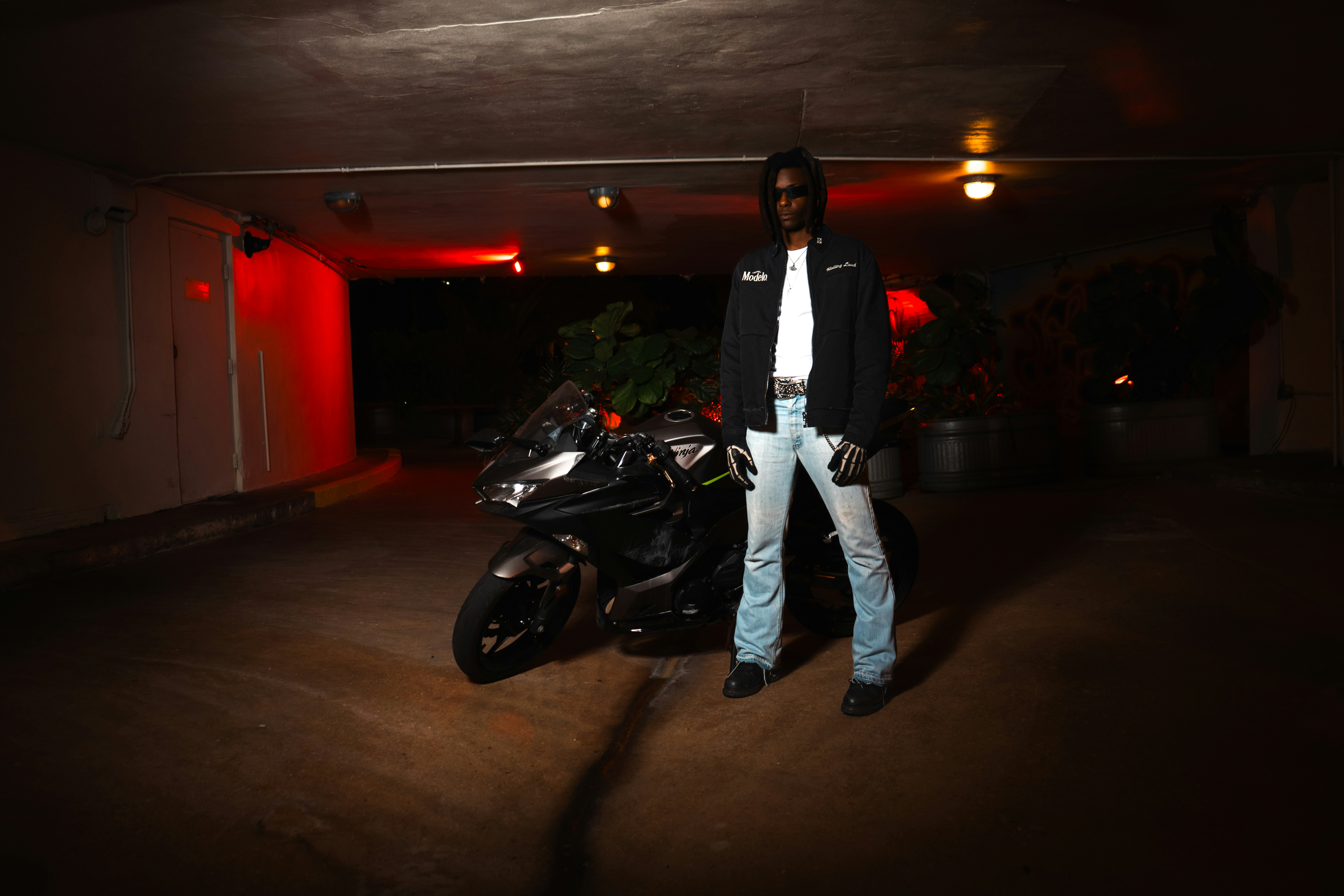 Midnight Rider: a solitary figure by a parked motorcycle in an underpass