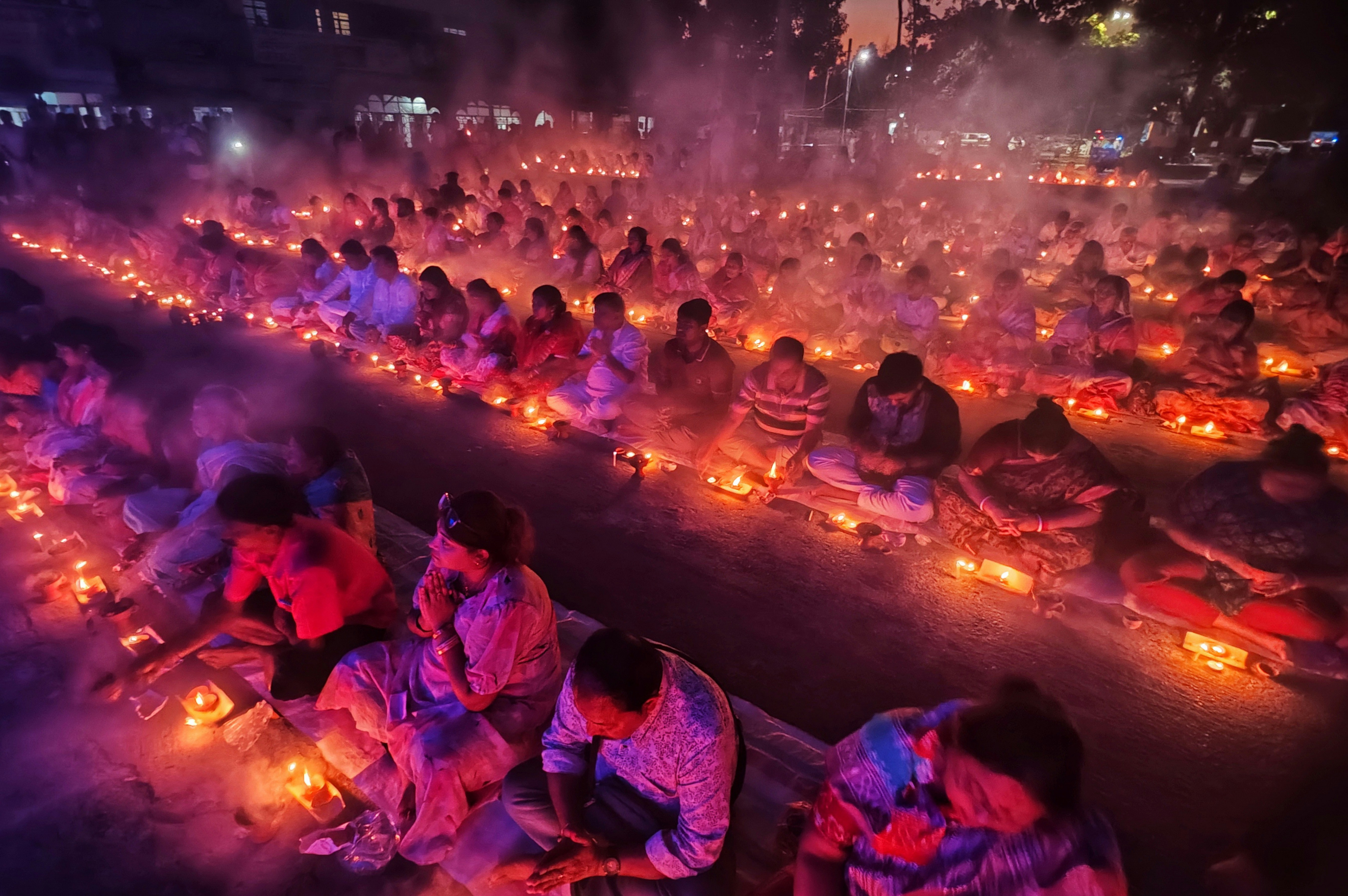Candlelit Vigil: Rows of Quiet Fire in the Night