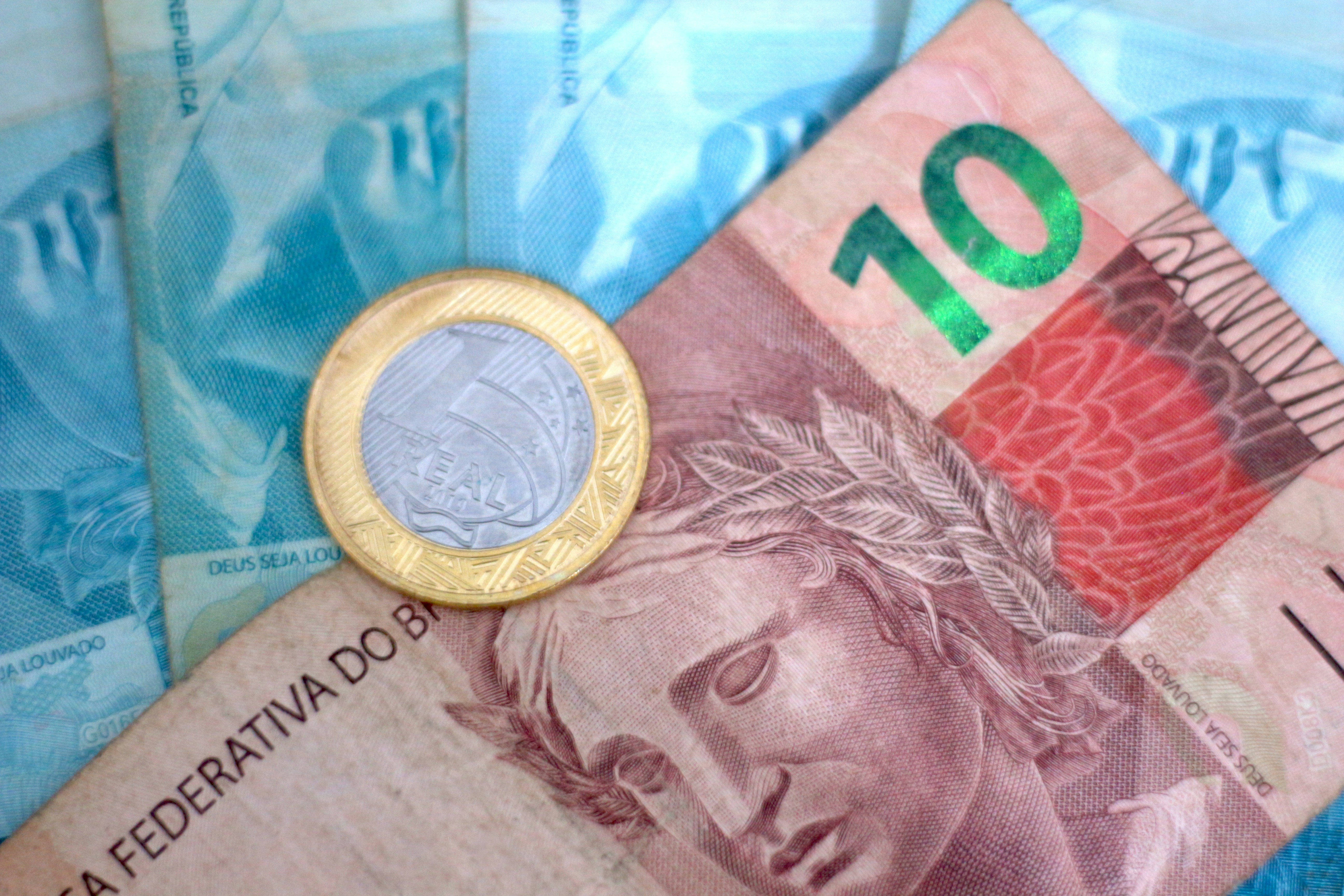 A close up of a money bill with a coin on top of it photo – Free ...