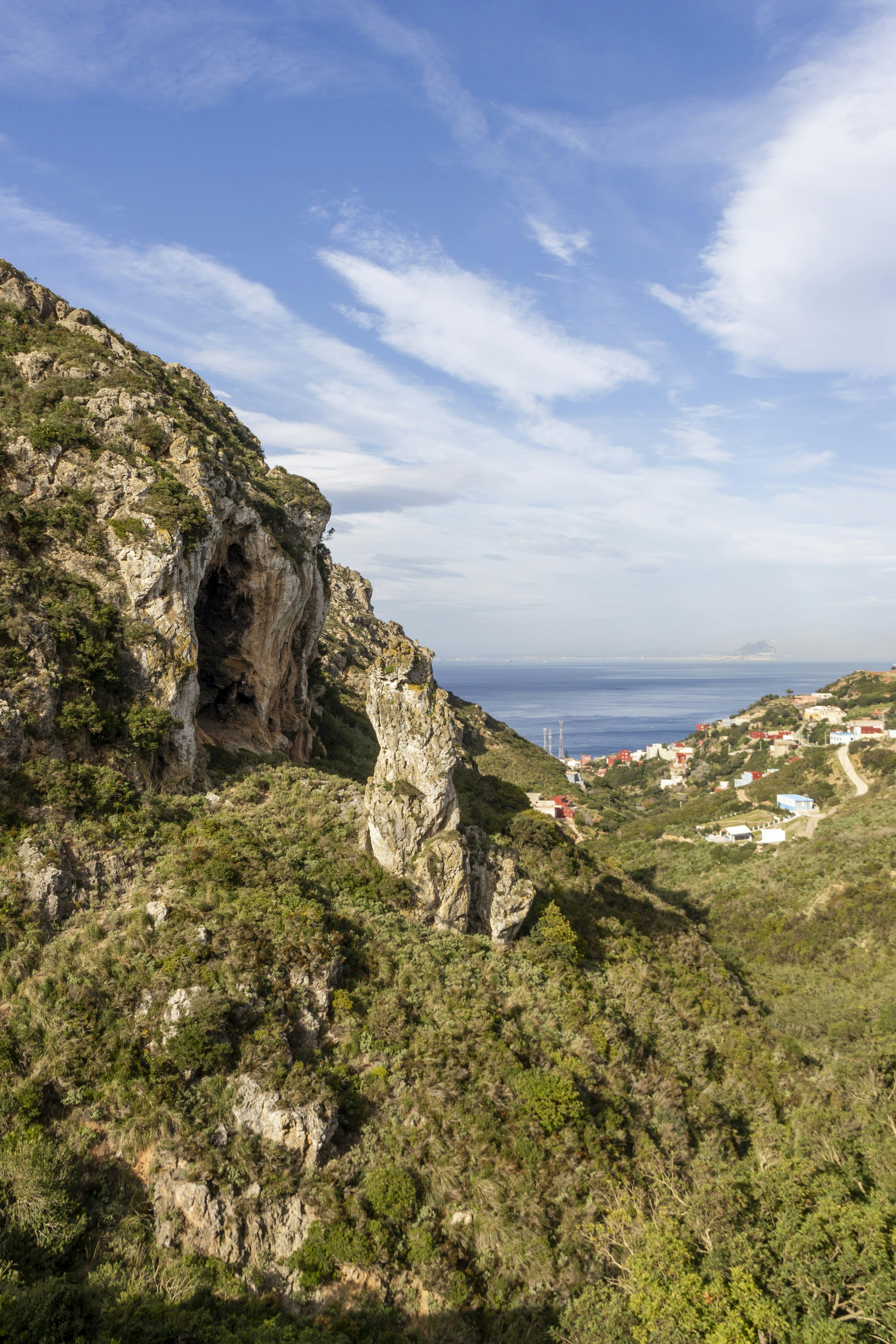 Cove-View Cliff: Sunlit Rock Face Framing a Mediterranean Coastline