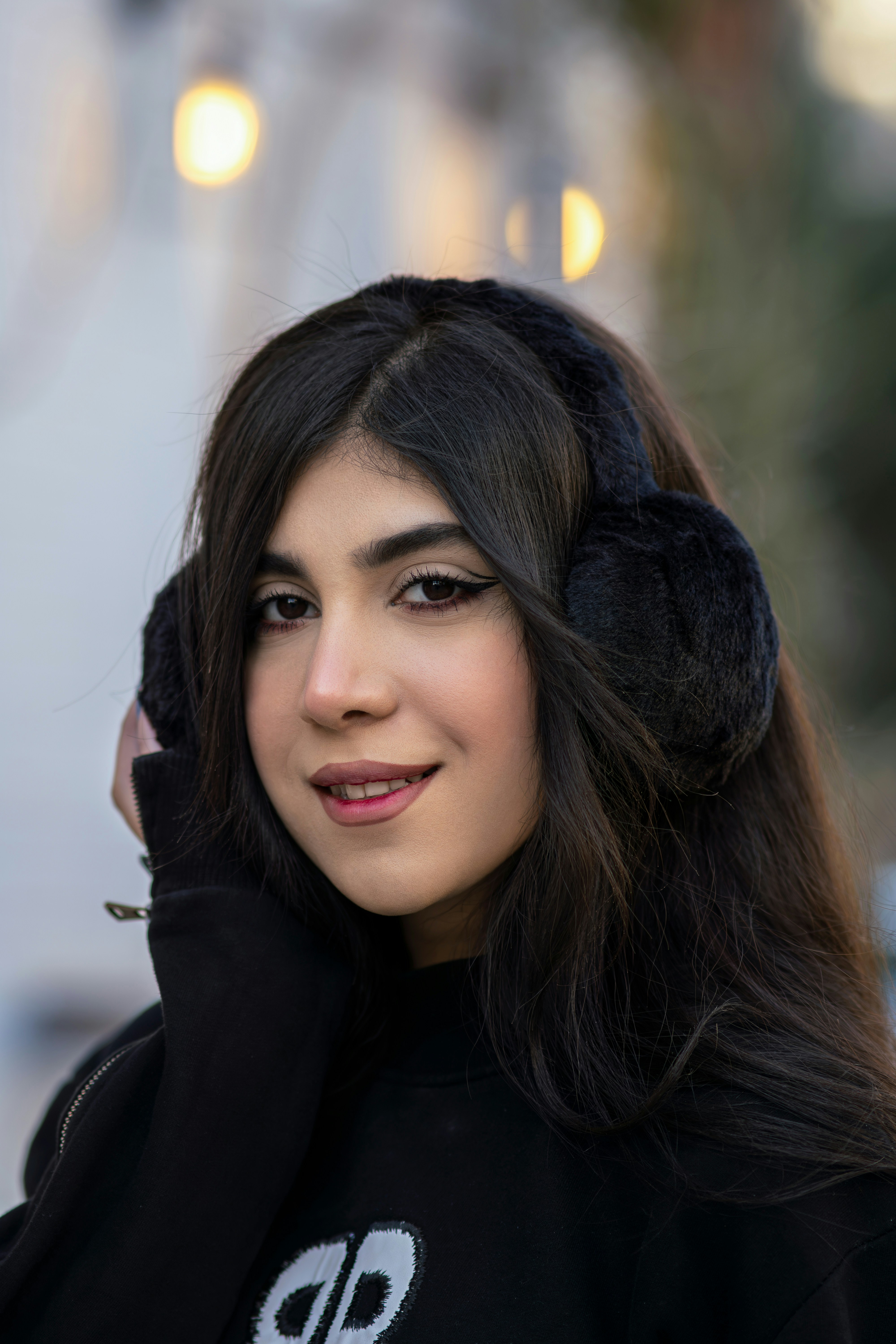 A woman in a black sweatshirt is talking on a cell phone photo – Free ...