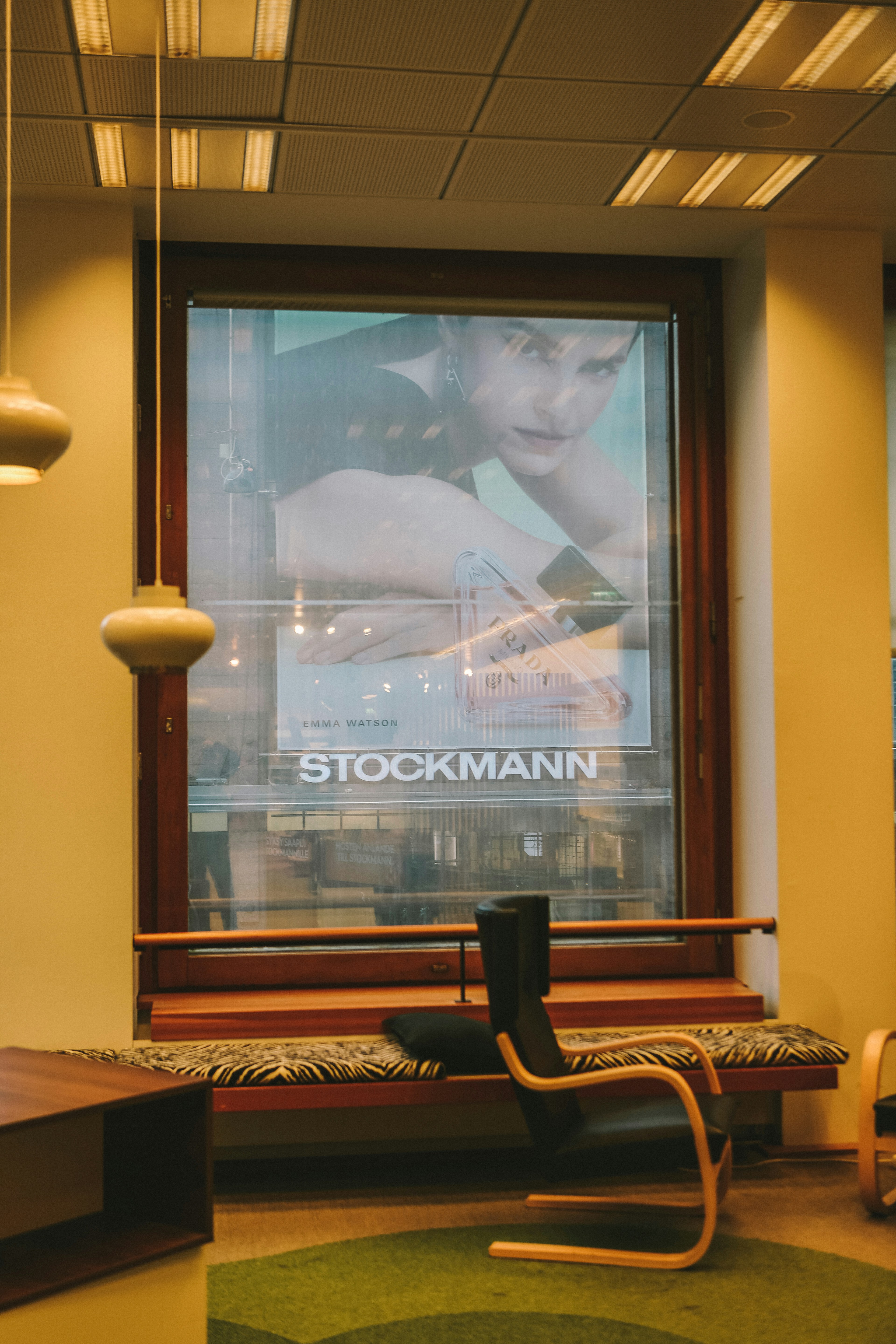 Window Viewfinding: Stockmann Billboard Reflected in Cozy Lounge