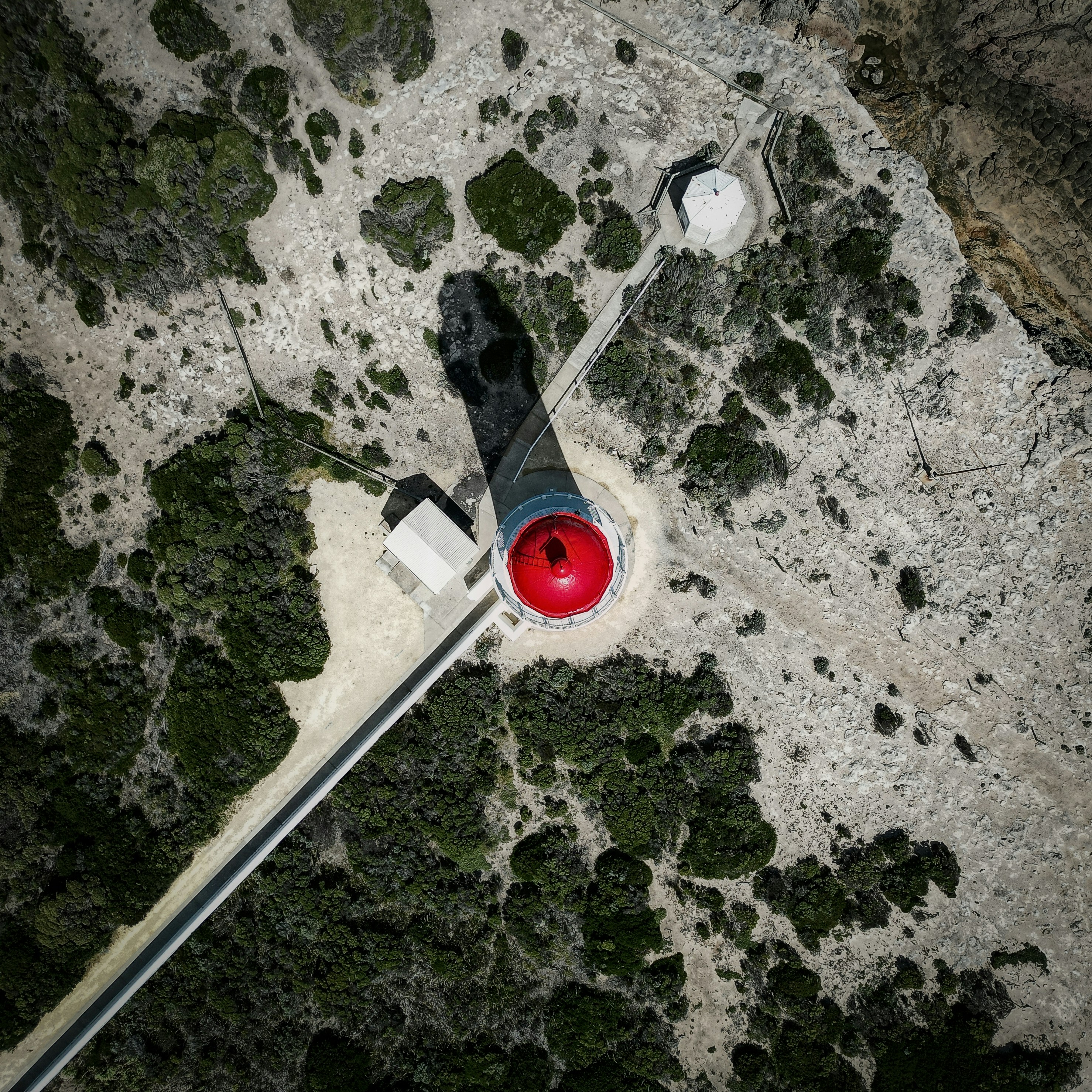 Red Beacon at the Peak: Aerial View of the Deserted Tower