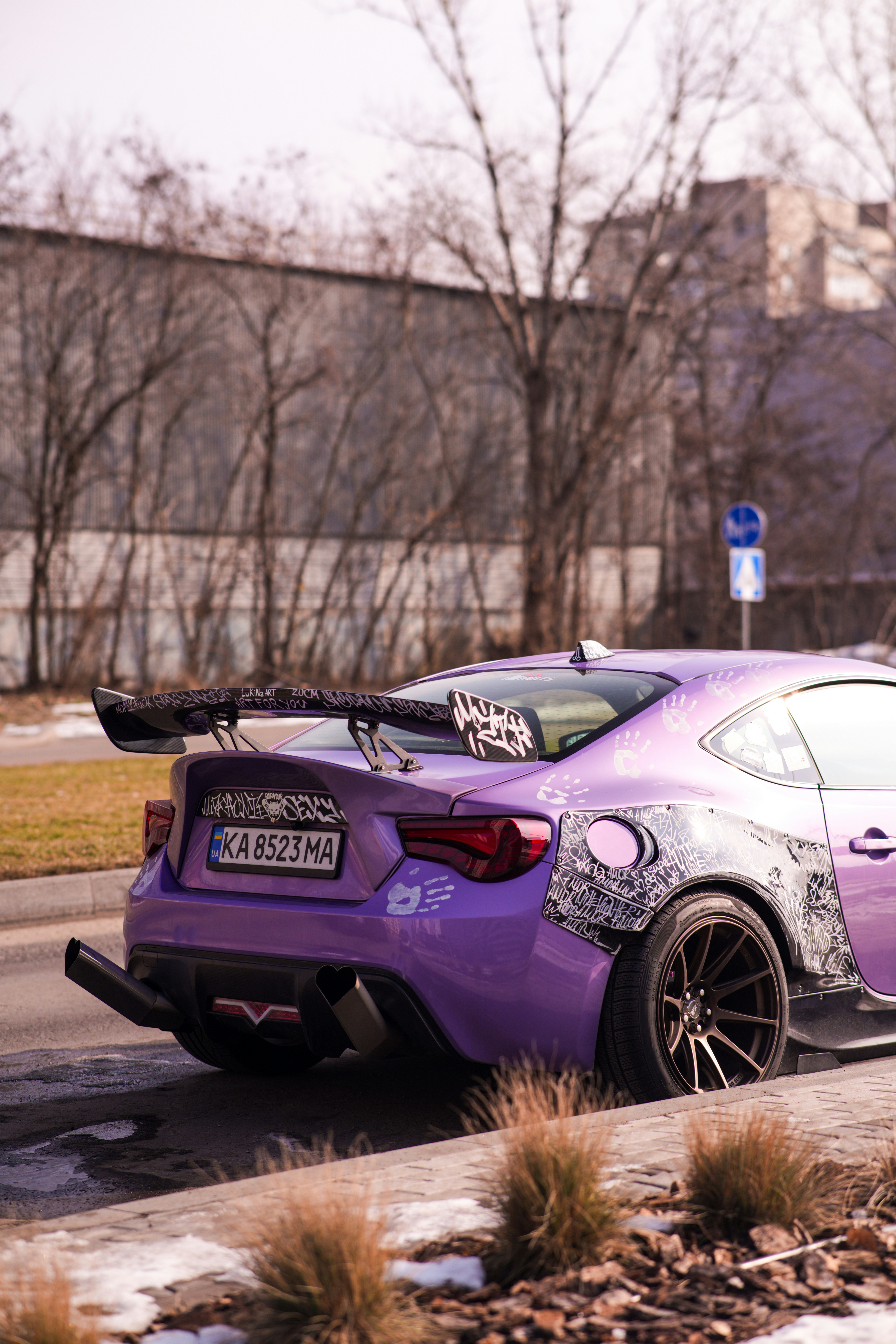 Graffiti-Wrapped Velocity: Purple Coupé with a Race-Ready Wing