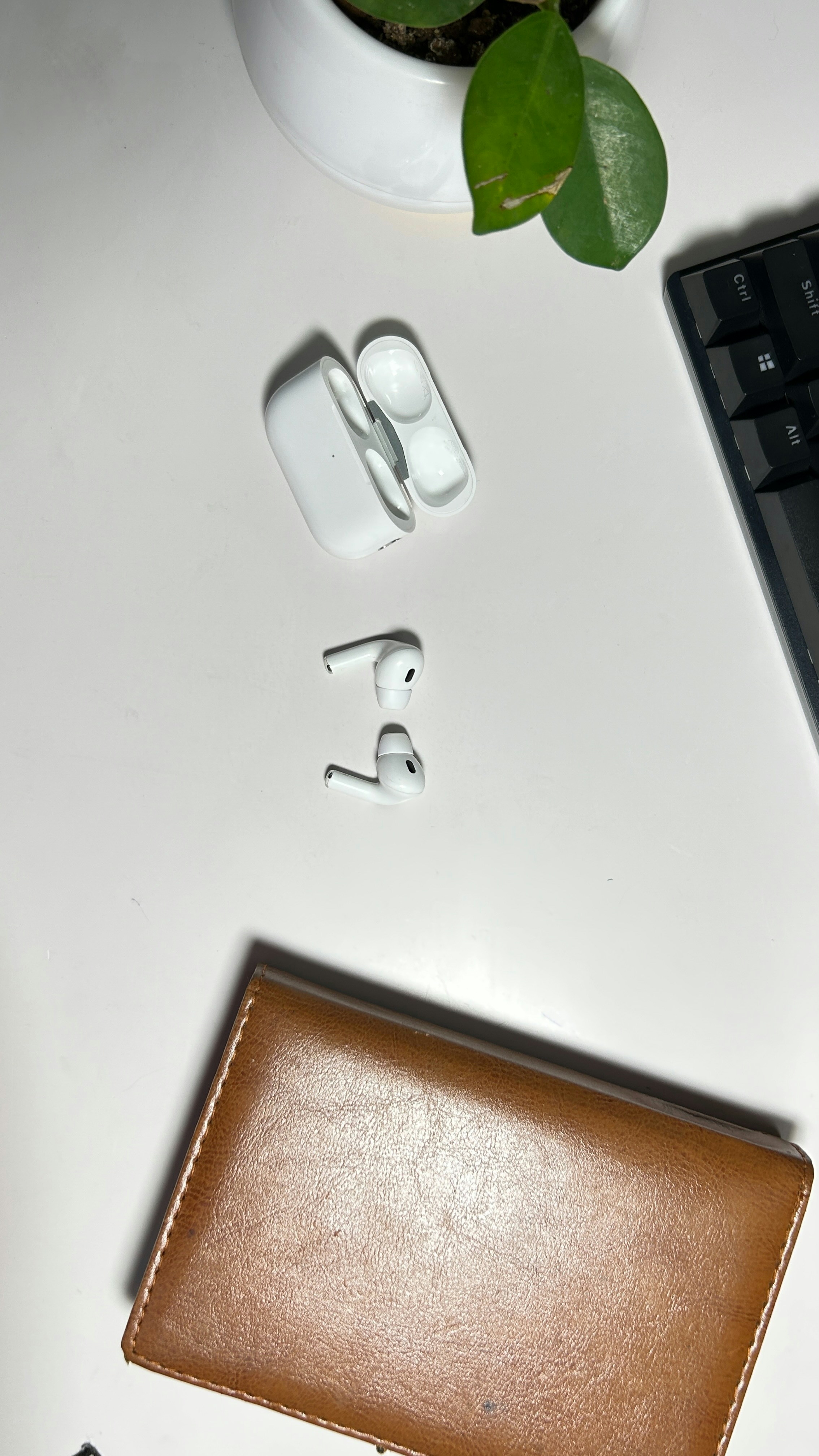 AirPods Pro Case and Wallet on a Clean White Desk