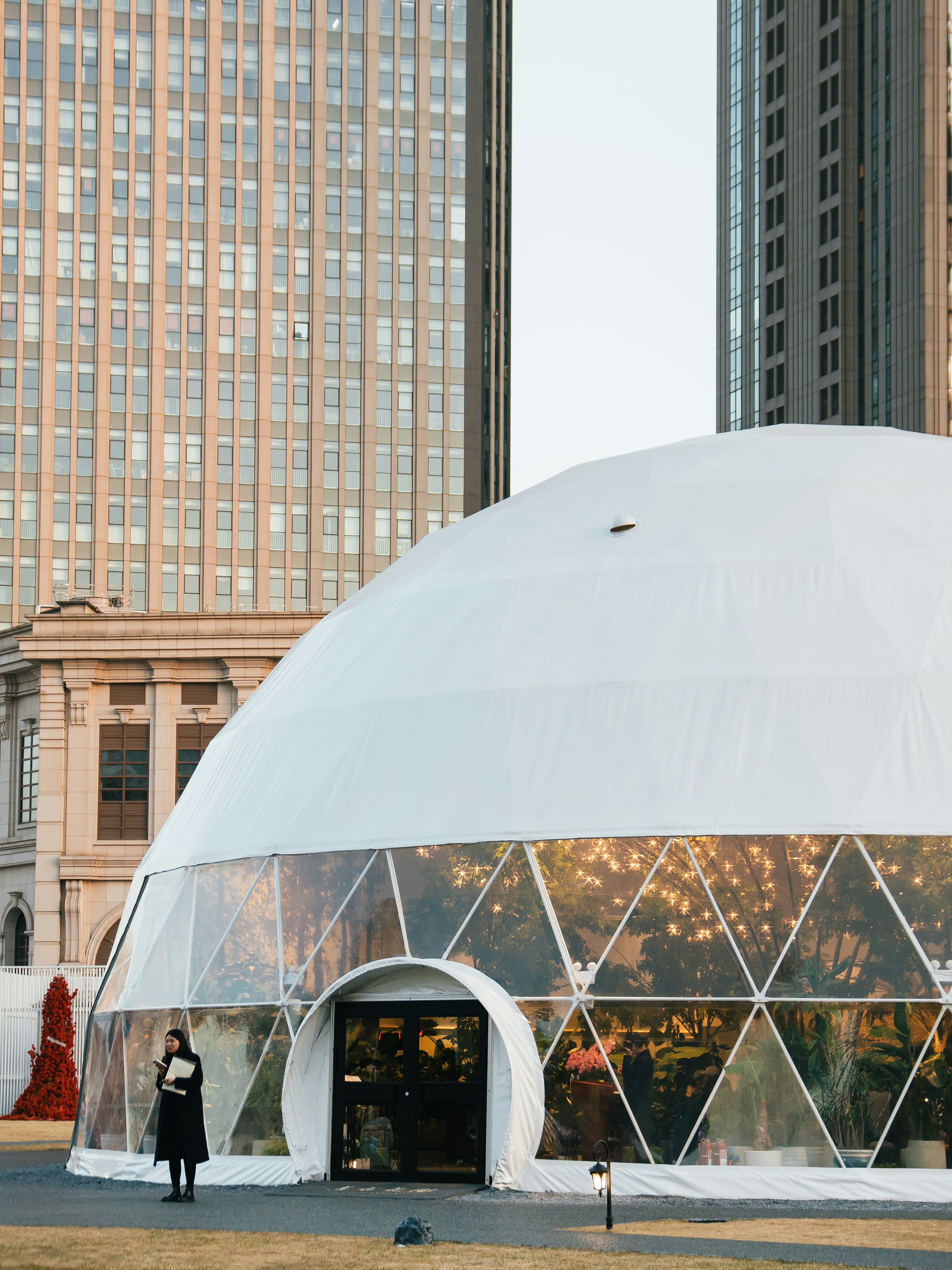 Geodesic Dome in the City: A Transparent Pavilion Framed by Towers