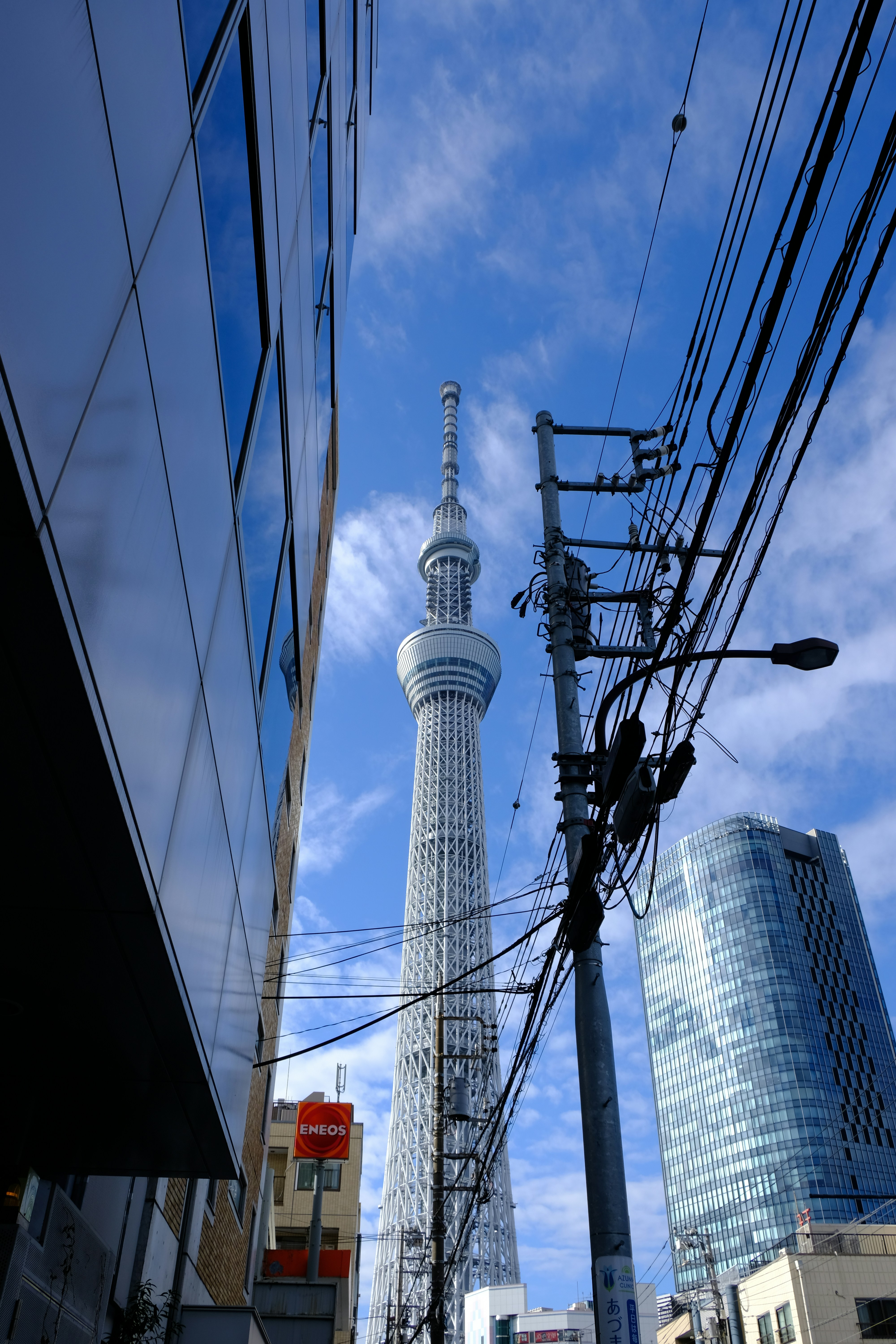 A tall tower towering over a city next to tall buildings photo – Free ...