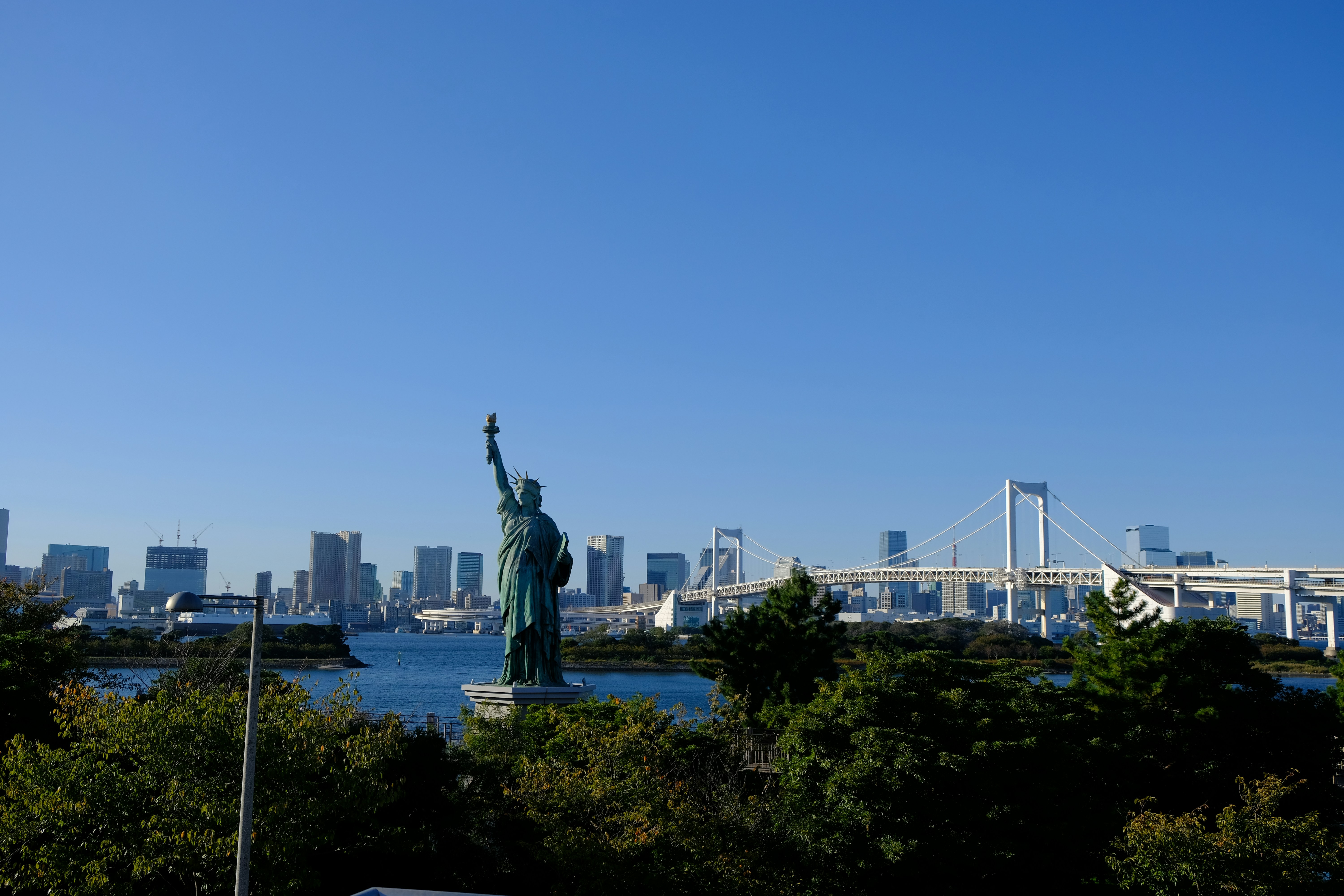 Statue and Skyline Harmony in Tokyo Bay