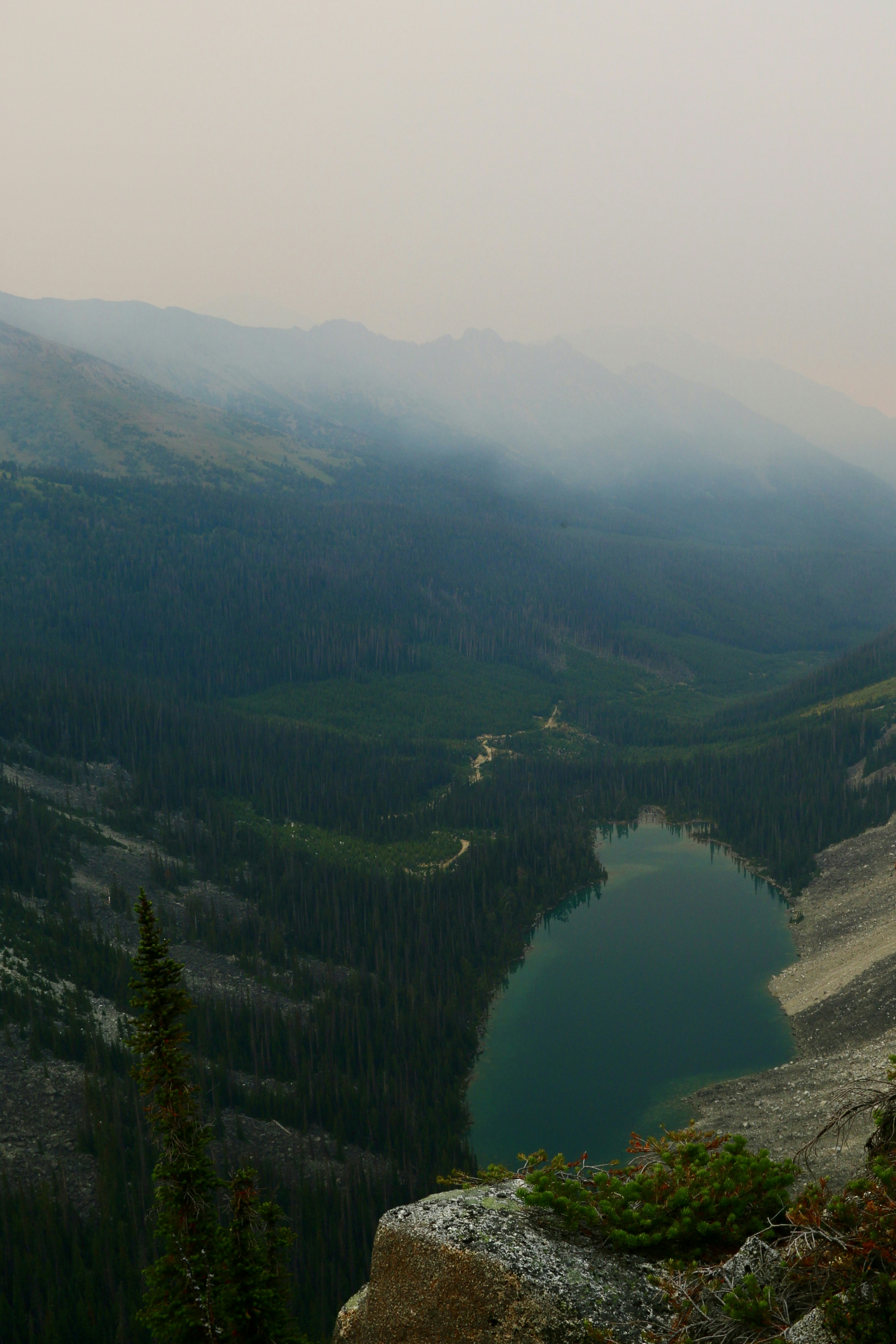 Azure Ribbon Lake Winding Through a Pine-Dusted Mountain Valley