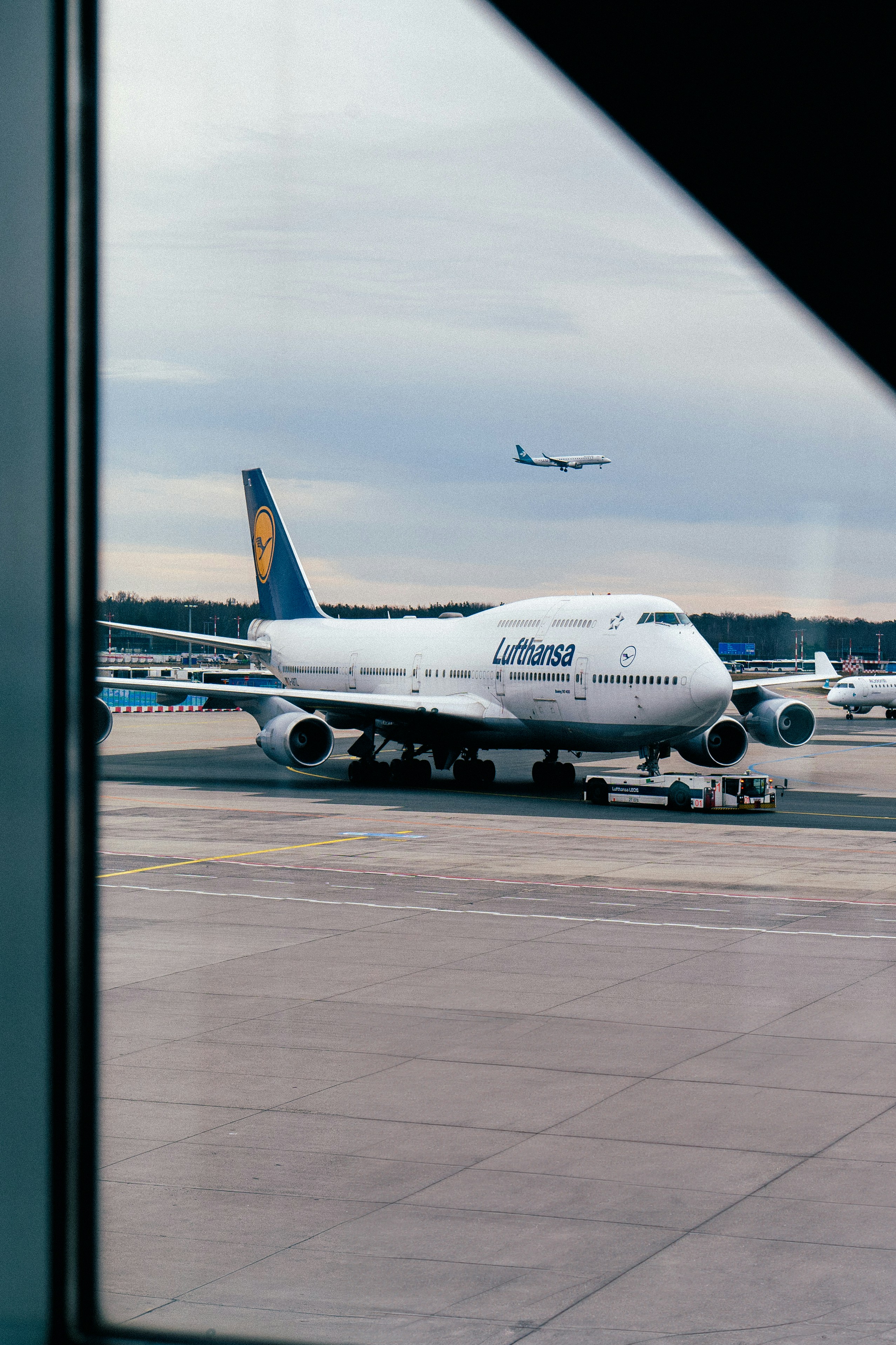 Framed in Glass: Lufthansa 747 at a Quiet Gate