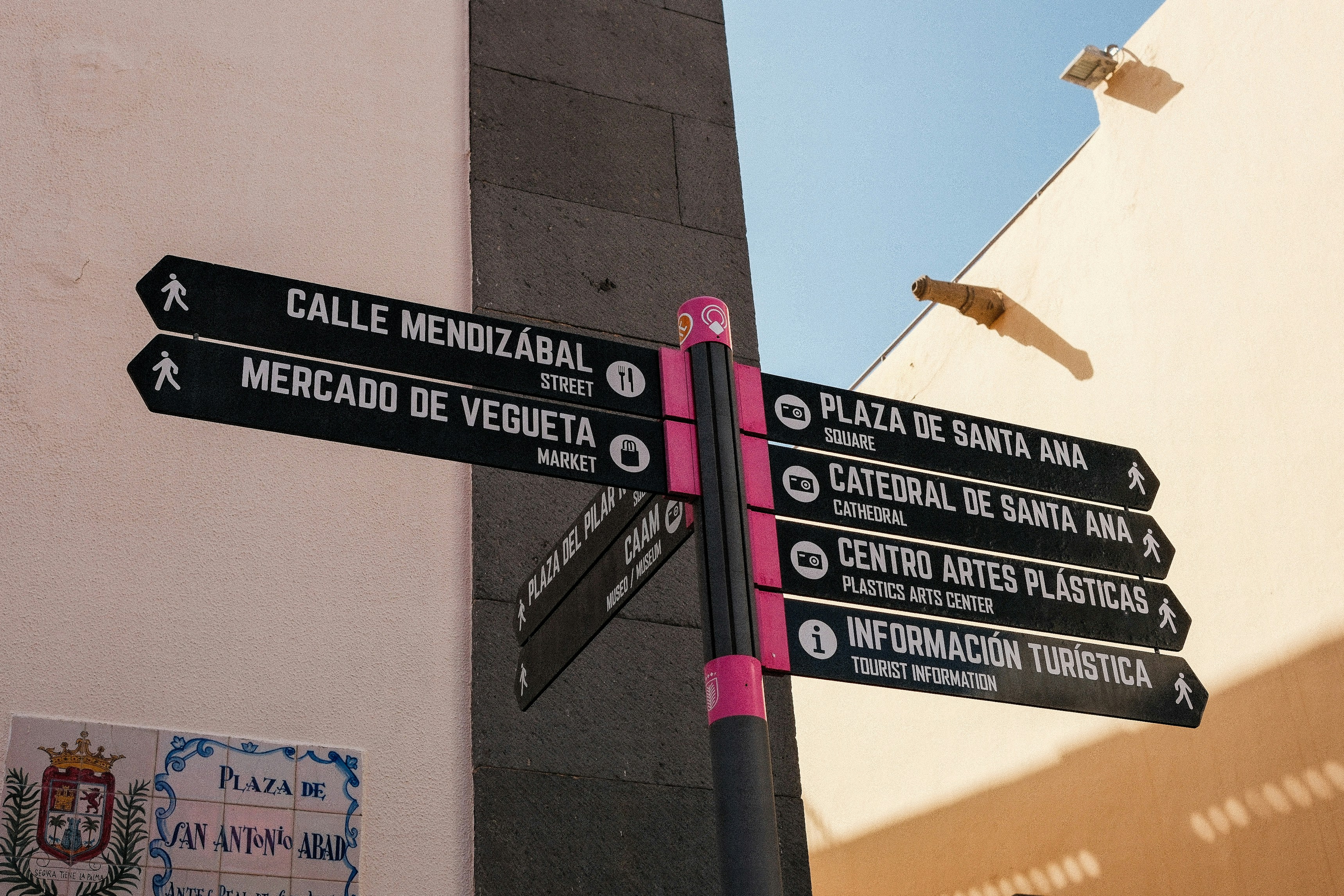 A pole with a bunch of street signs on itDhiemas Afif Febriyan