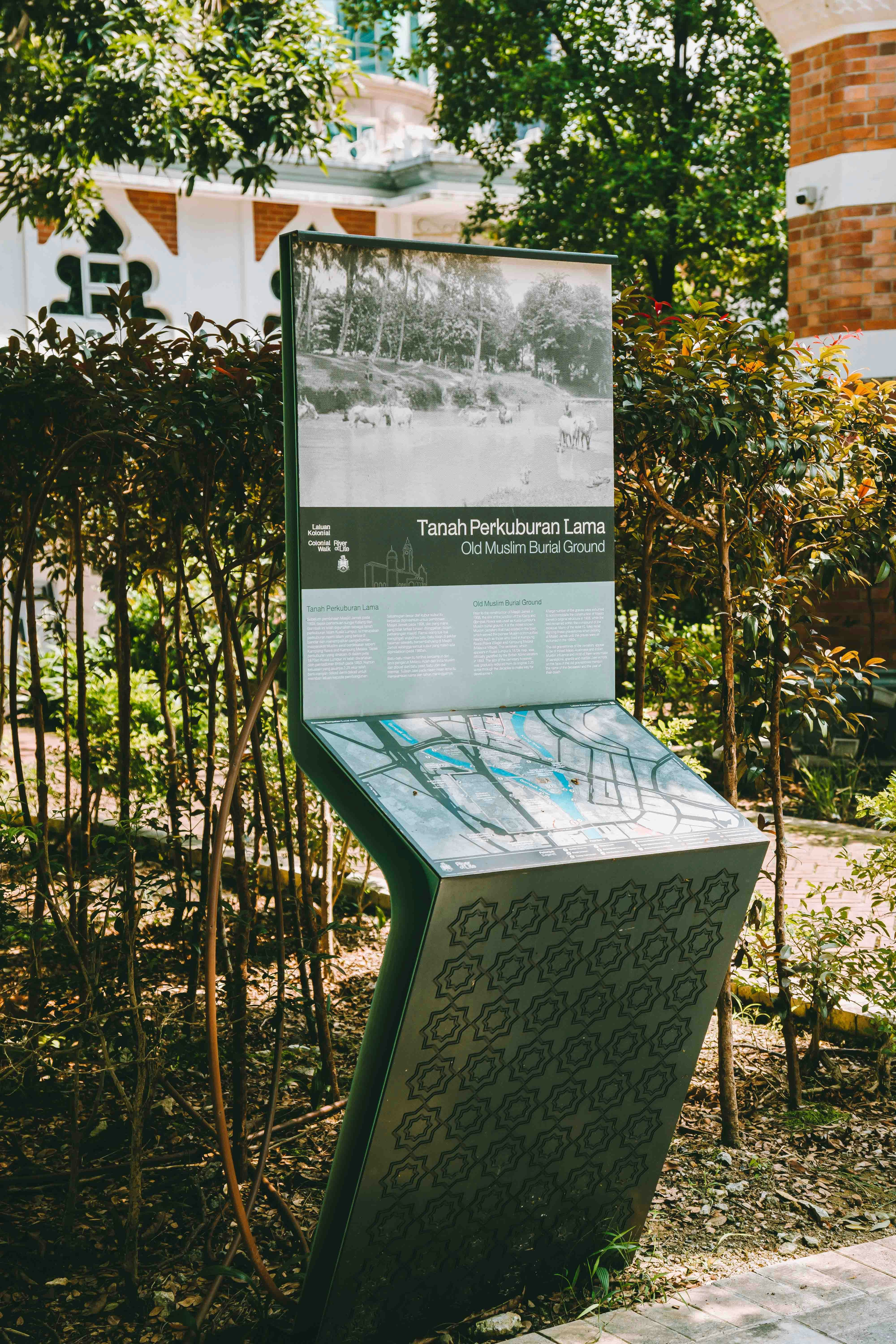Heritage Signpost by a Lush Garden: Old Muslim Burial Ground Exhibit