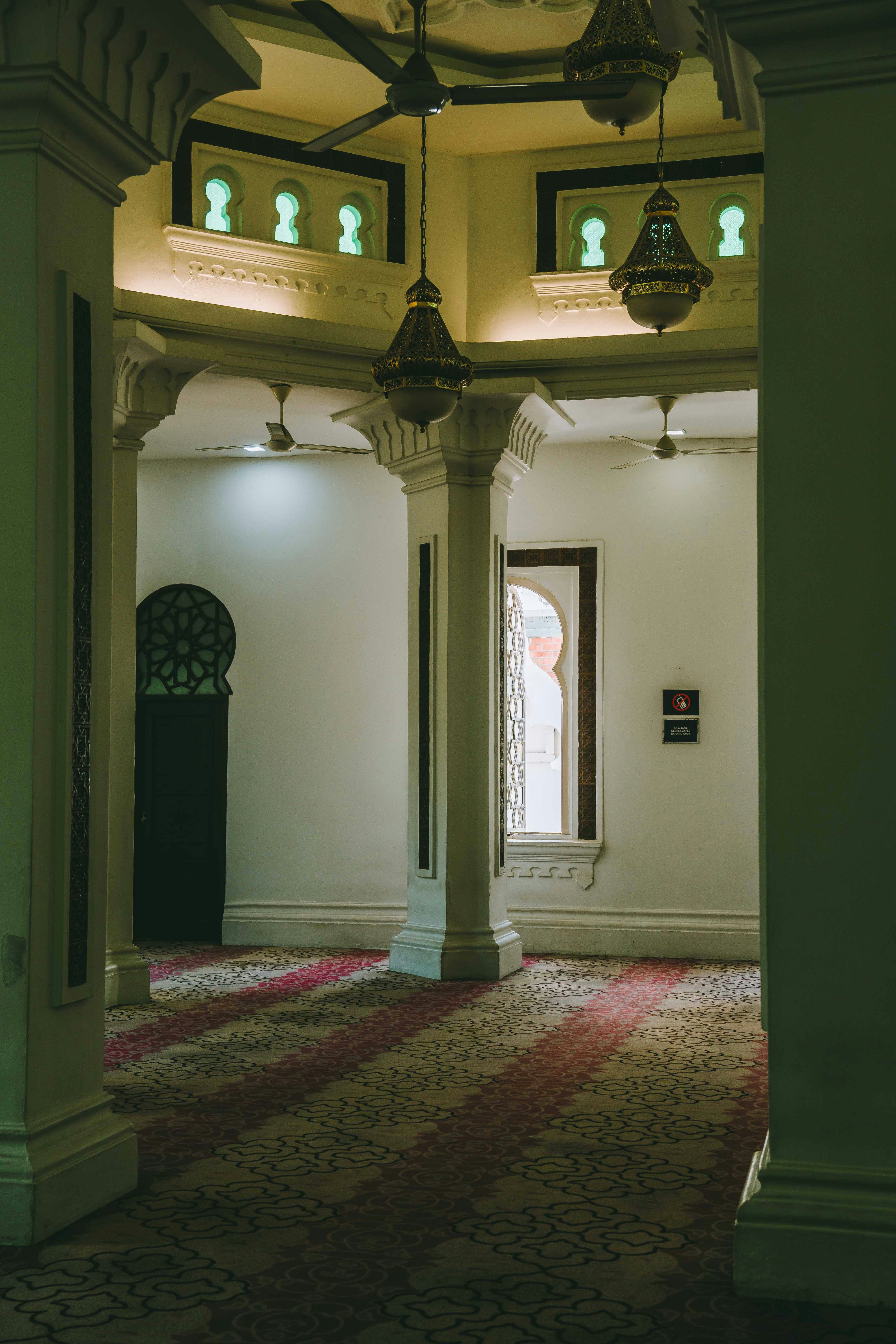 Daylight at a Doorway: Lanterns and Archways in a Quiet Corridor