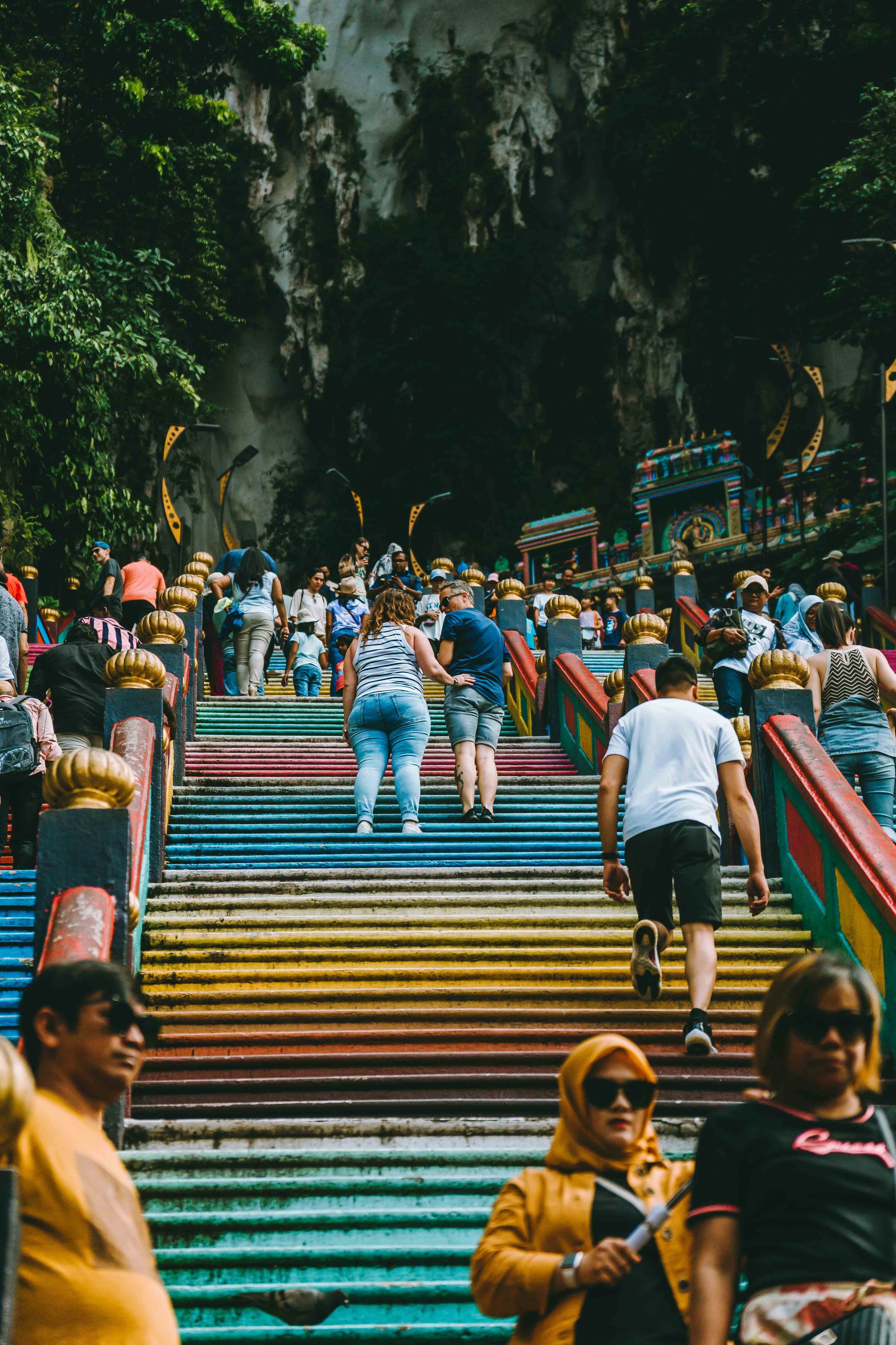 Colorful Descent: A Busy Temple Staircase Teeming with Visitors