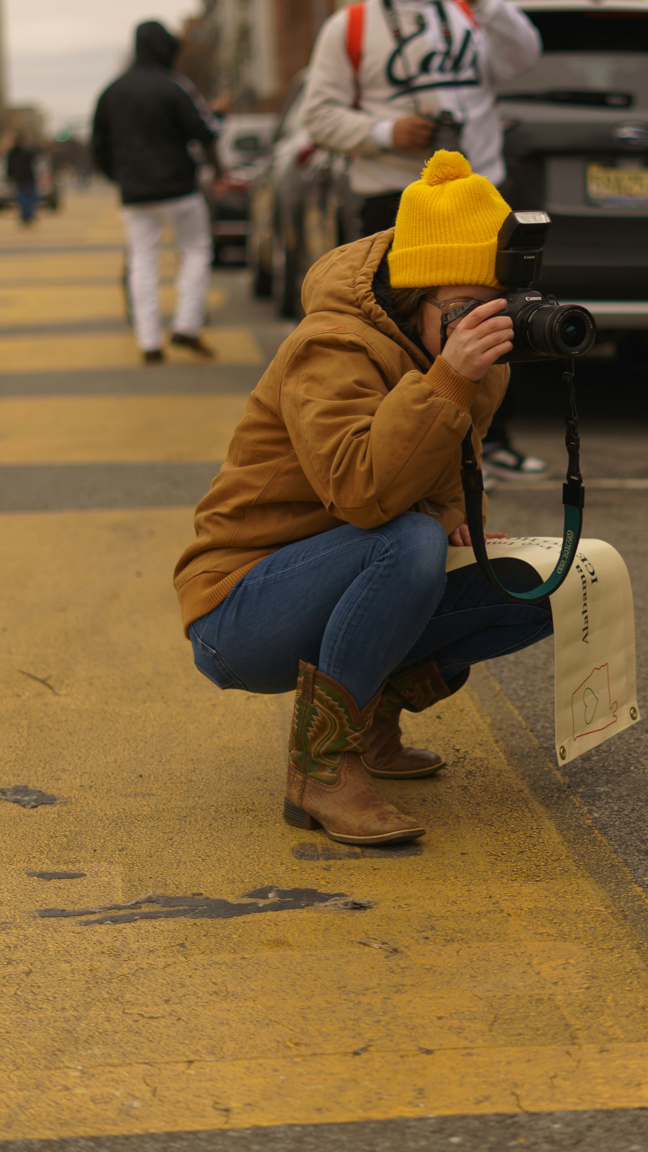The Moment Caught: A Young Photographer in a Yellow Beanie