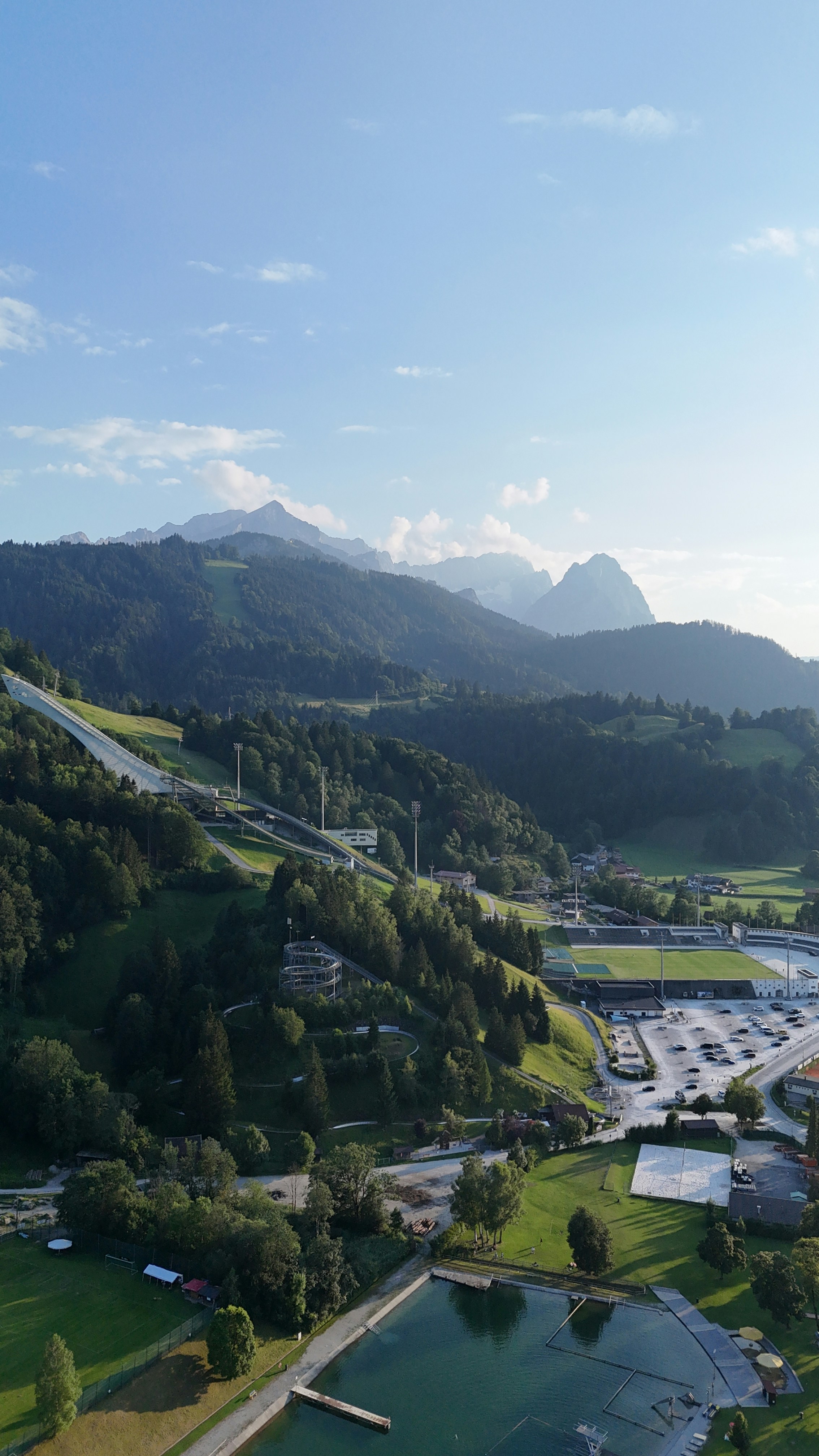 Alpine Valley Overlook: Green Ridges, Winding Roads, and Distant Peaks