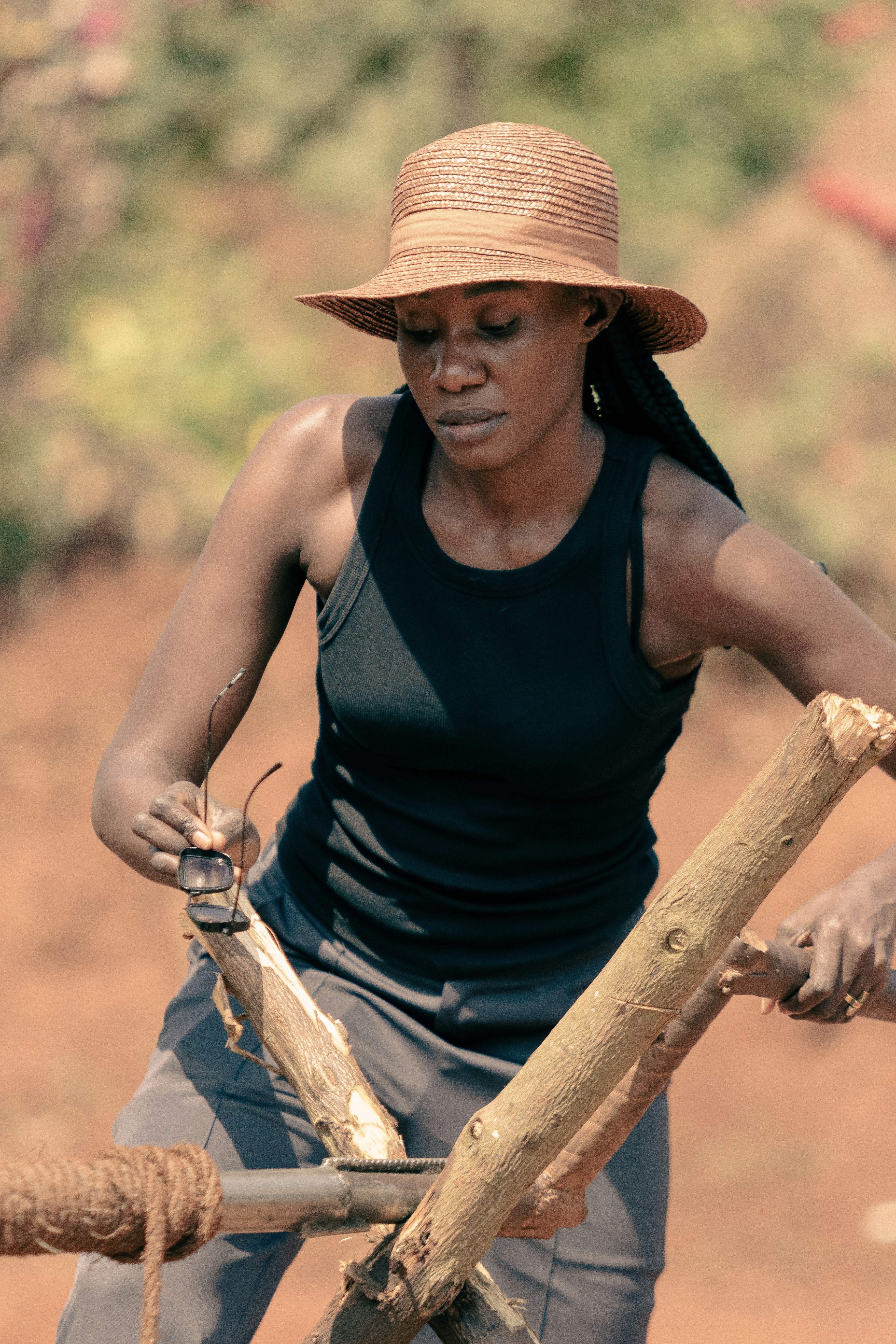 A woman holding a stick and a wooden stick photo – Free Farm Image on ...