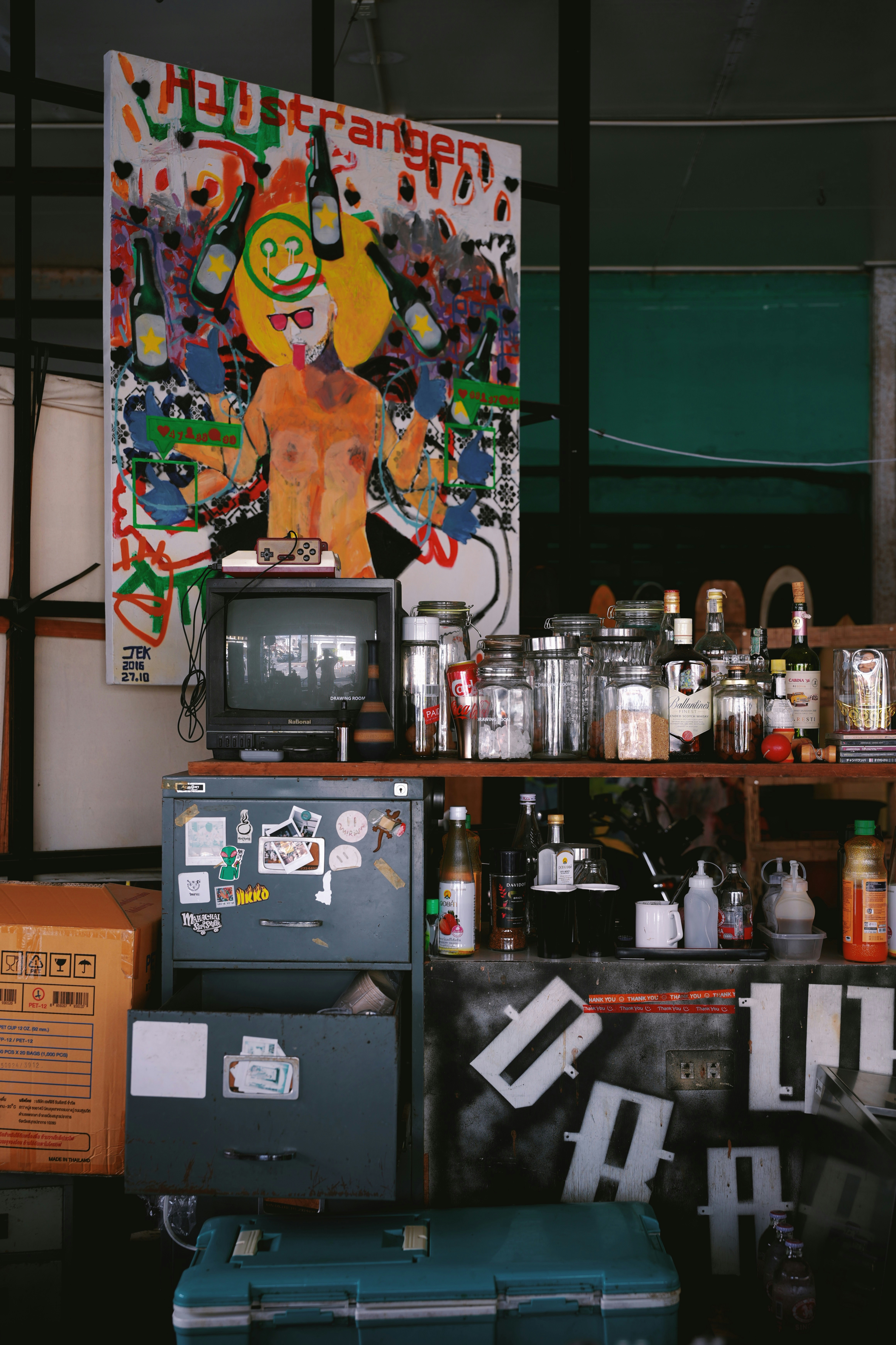 Vivid Mural of a Shirtless Figure Anchoring a Cluttered Bar Nook