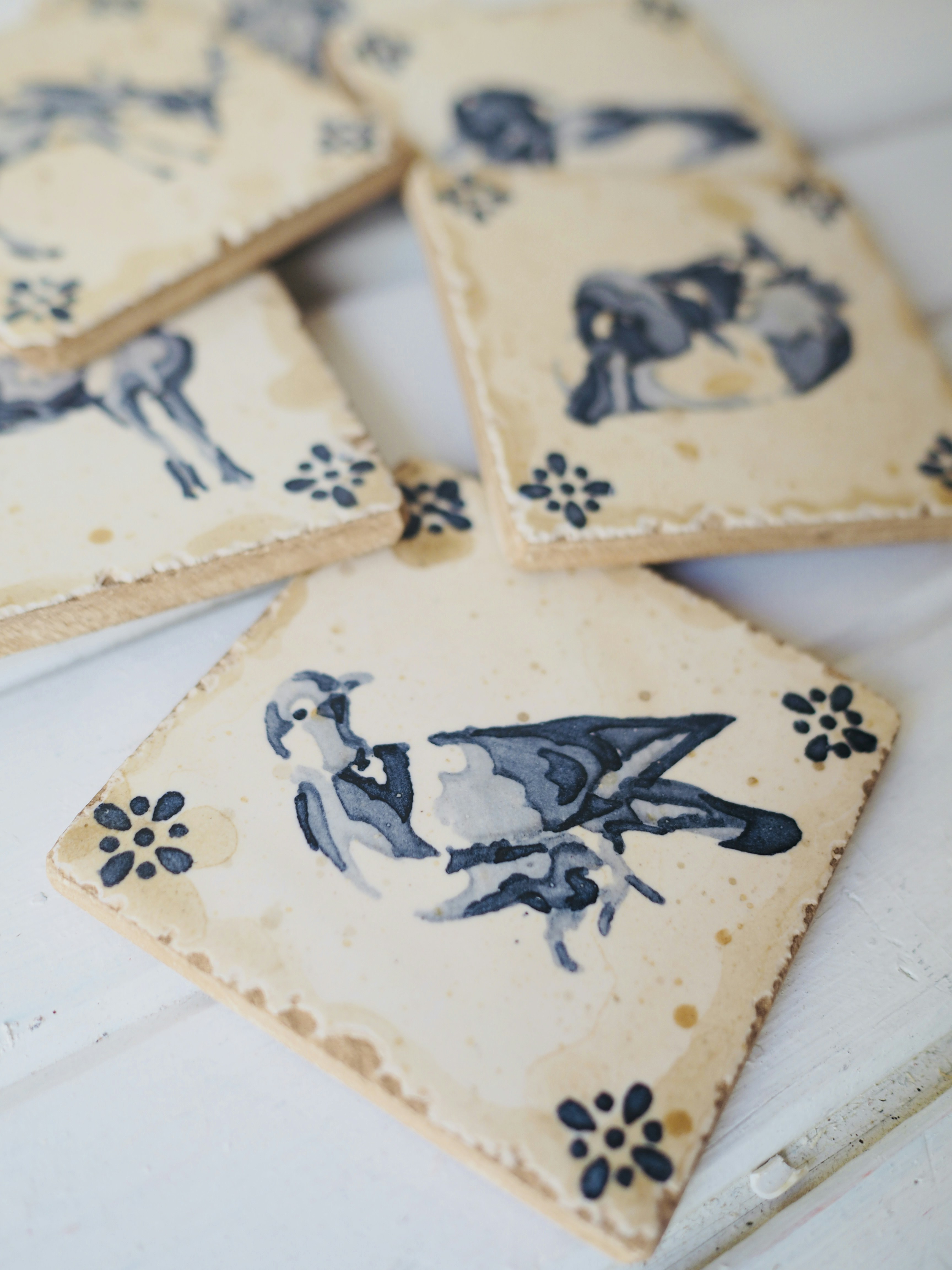 Whispers of Delft: A Quiet Mosaic of Birds on Cream Tiles