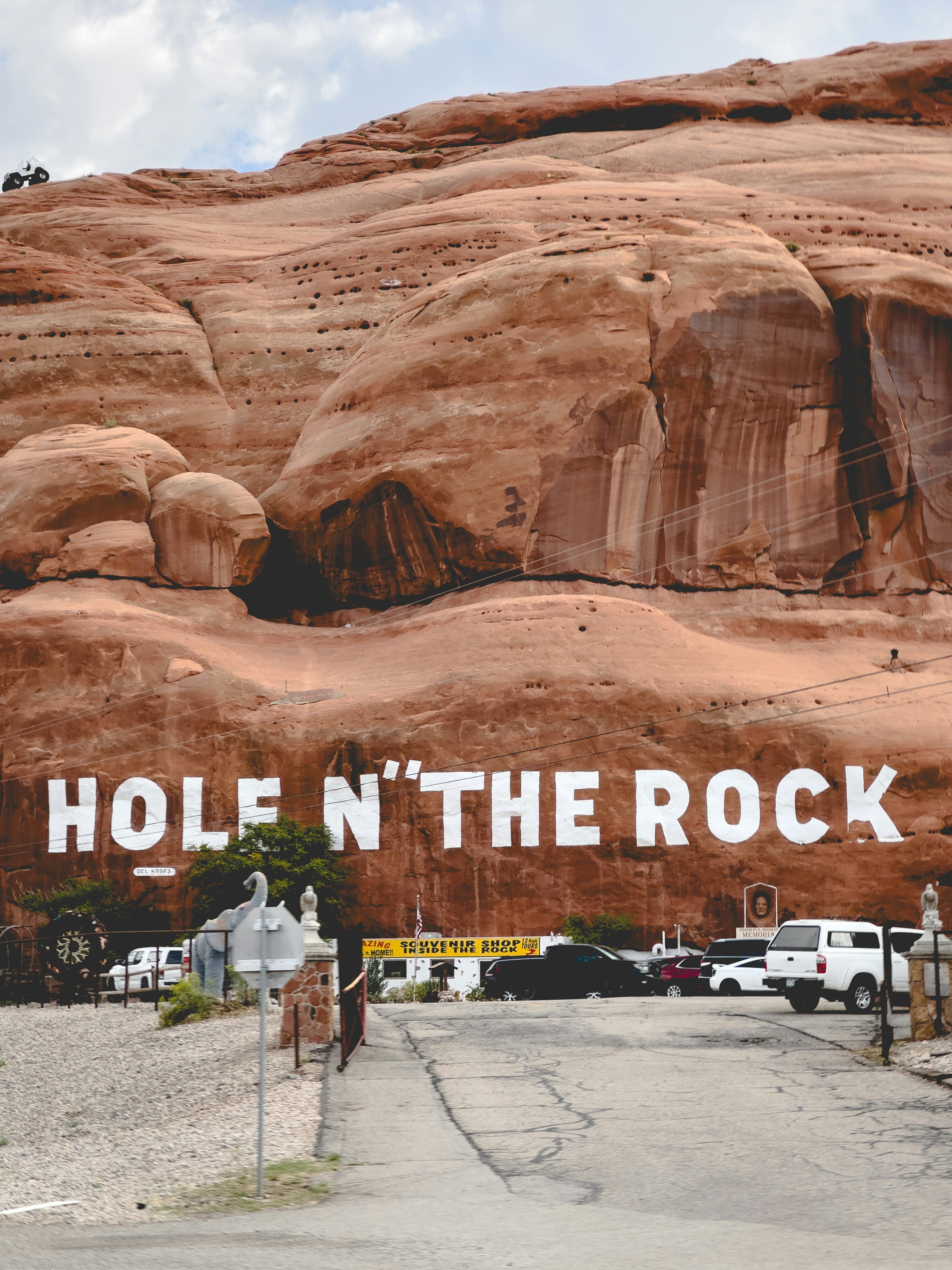 Desert Granite Welcome: Hole N' The Rock Sign on Red Stone