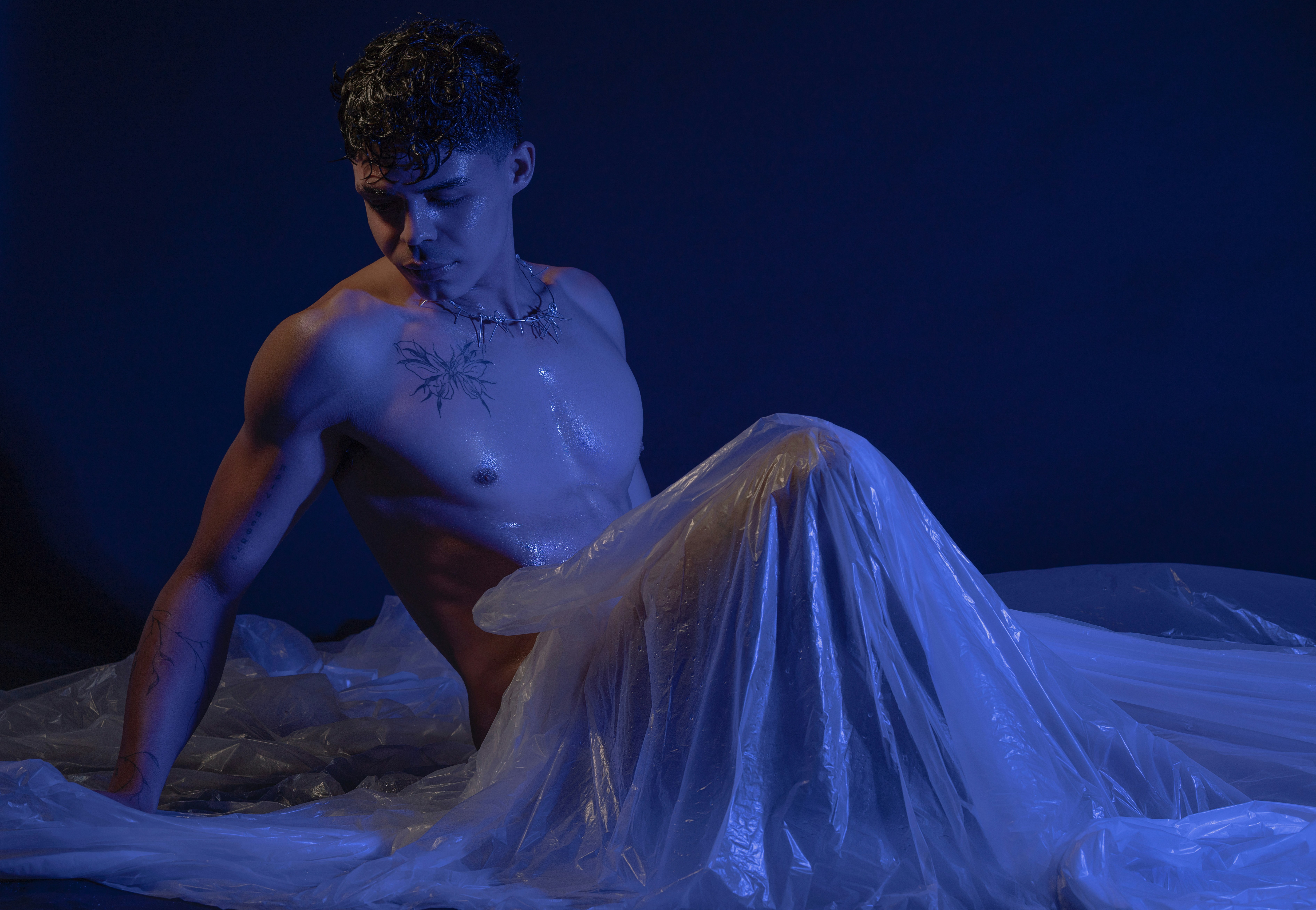 SEBASTIÁN by MIKE MIKE and MOSS ATELIER. | A man sitting on a bed covered in plastic