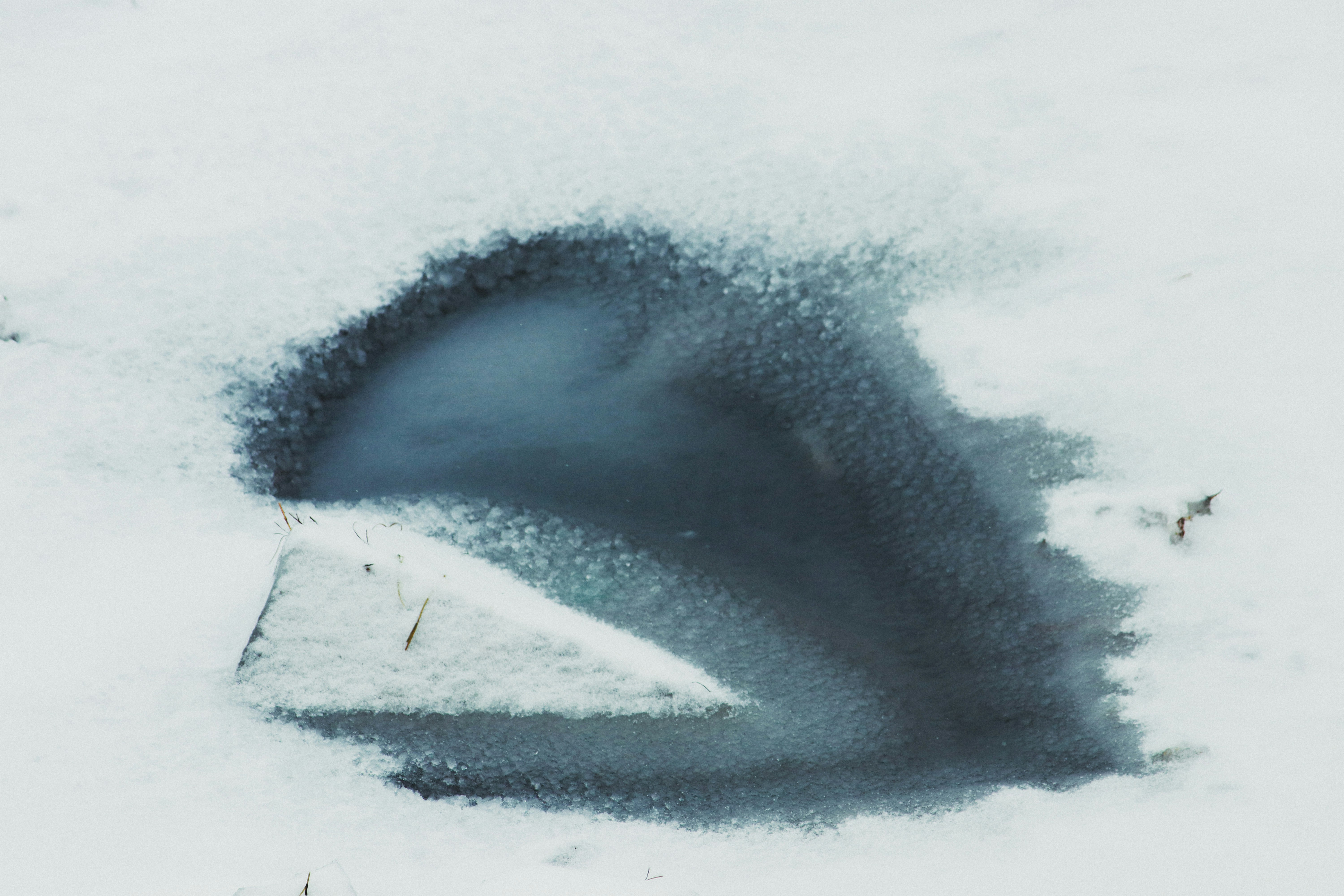 Ice hole reveals a triangular shape below. photo – Free Snow Image on ...