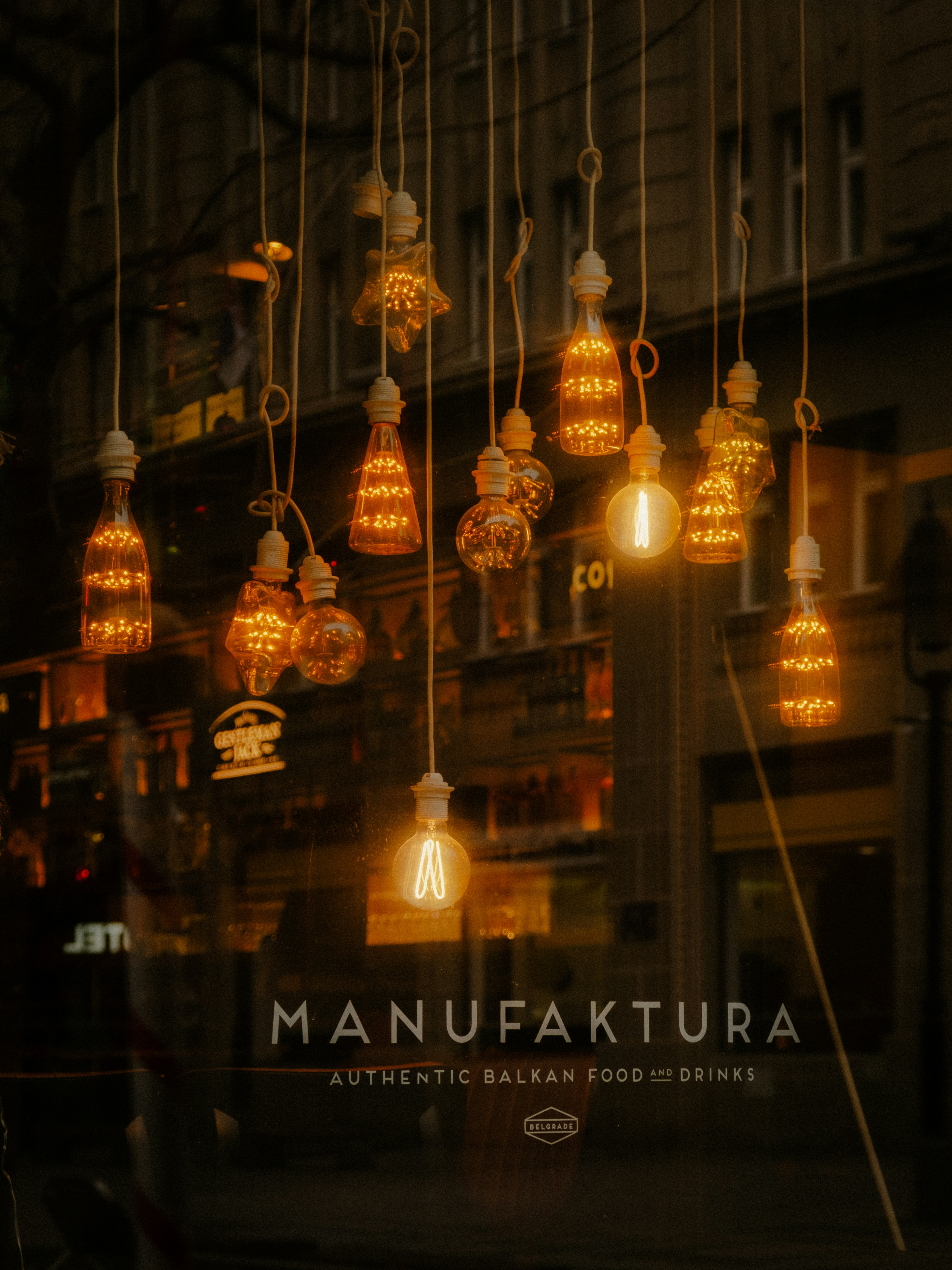 Glowing Orbs Above a storefront: MANU Faktura in amber